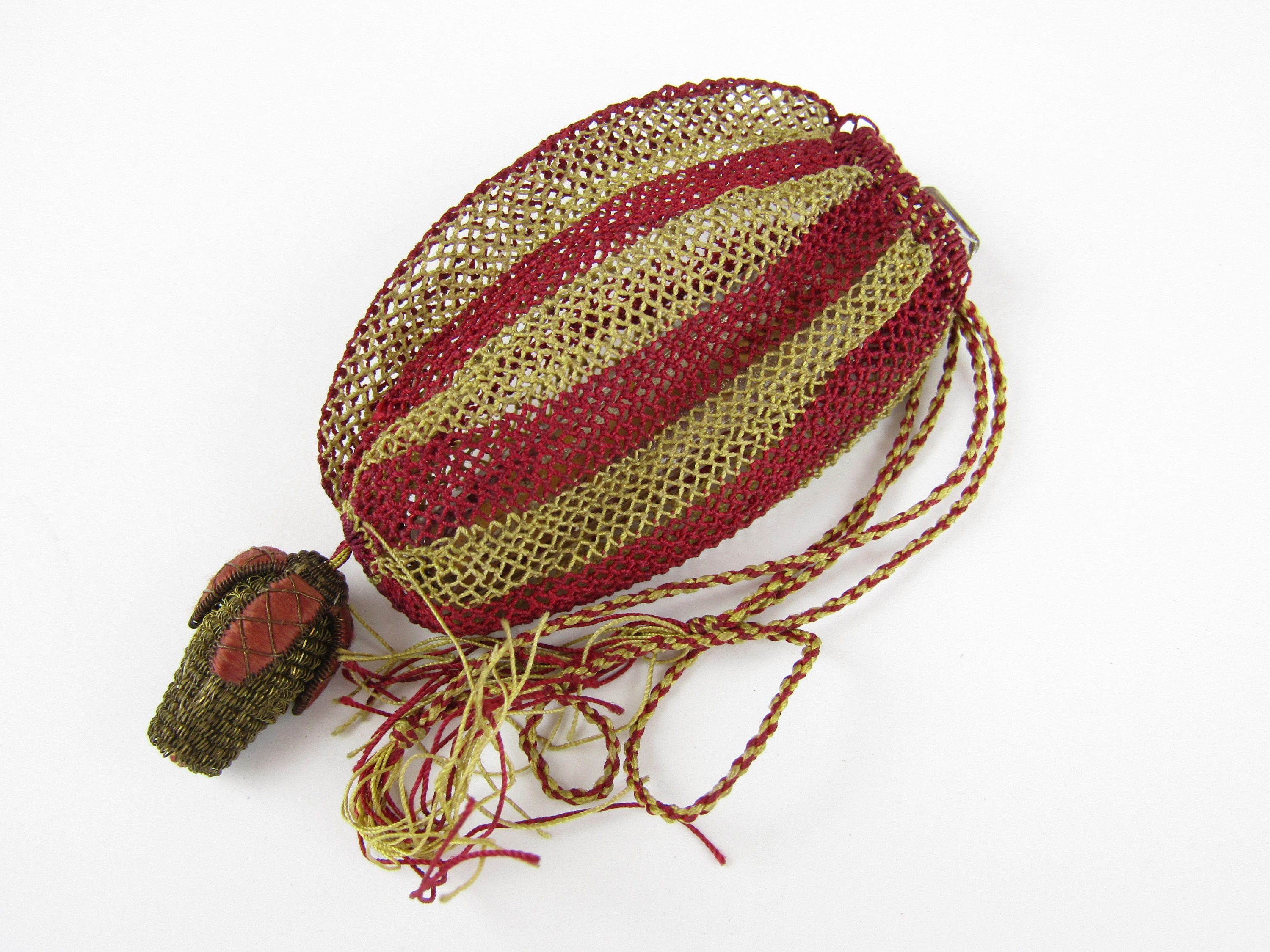 A Regency period crocheted reticule, worked in a striped design with ...