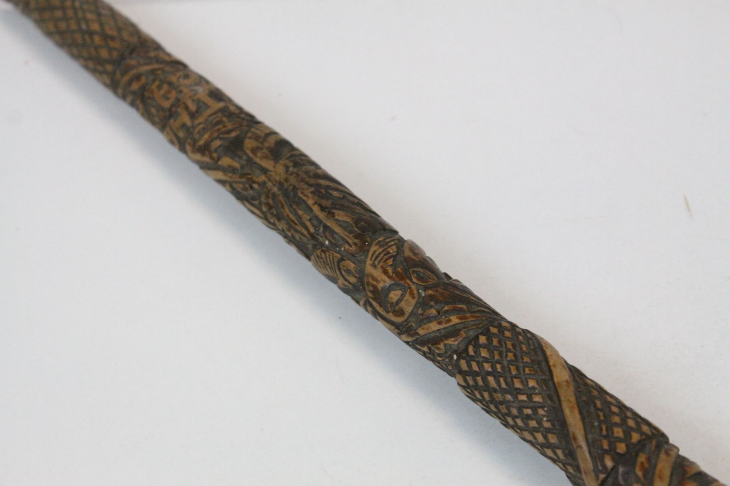 Tribal carved wooden stick with inscription
