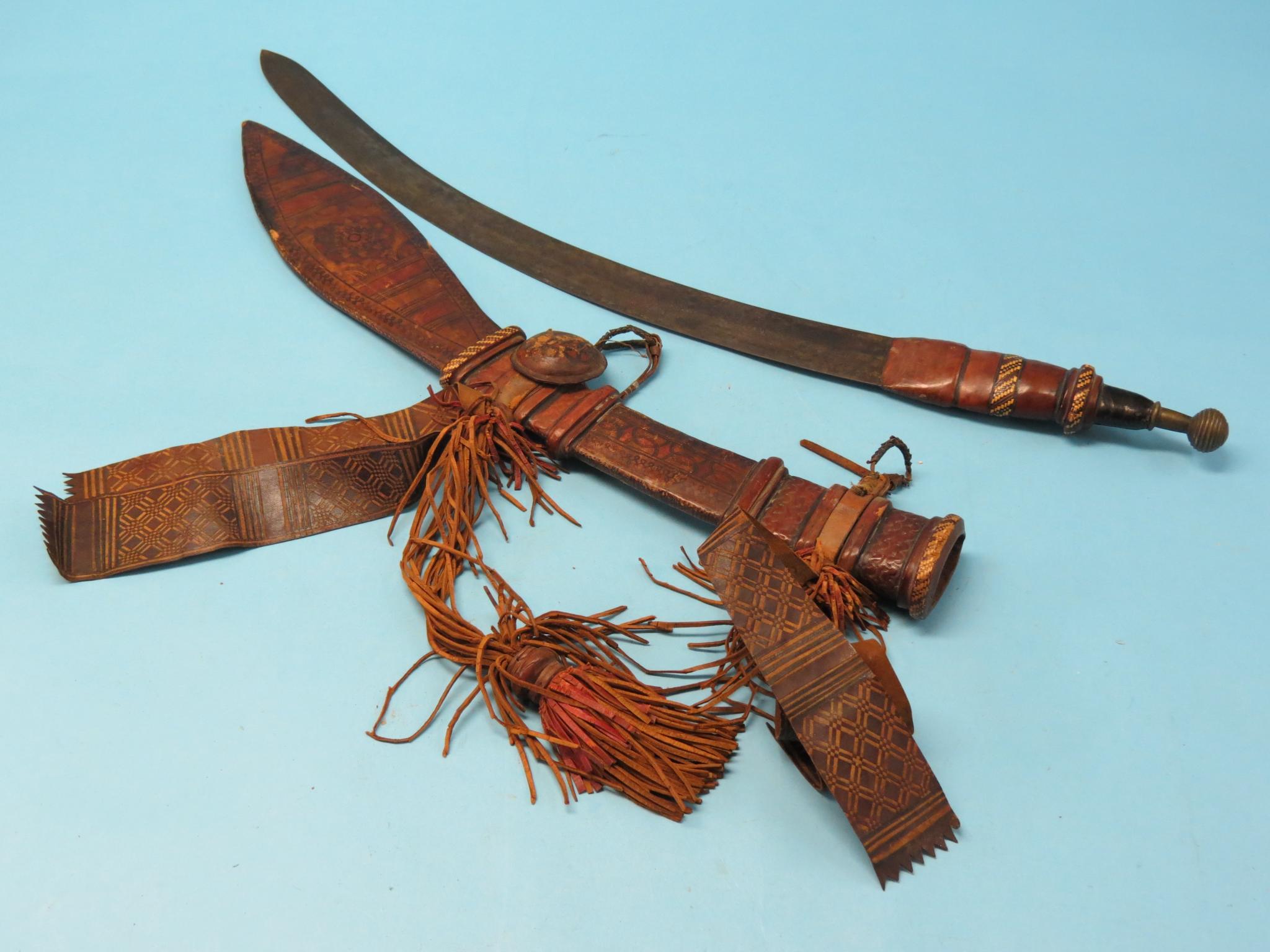 An African mandingo sword, 24in. curved, single-edged blade, hilt with ...