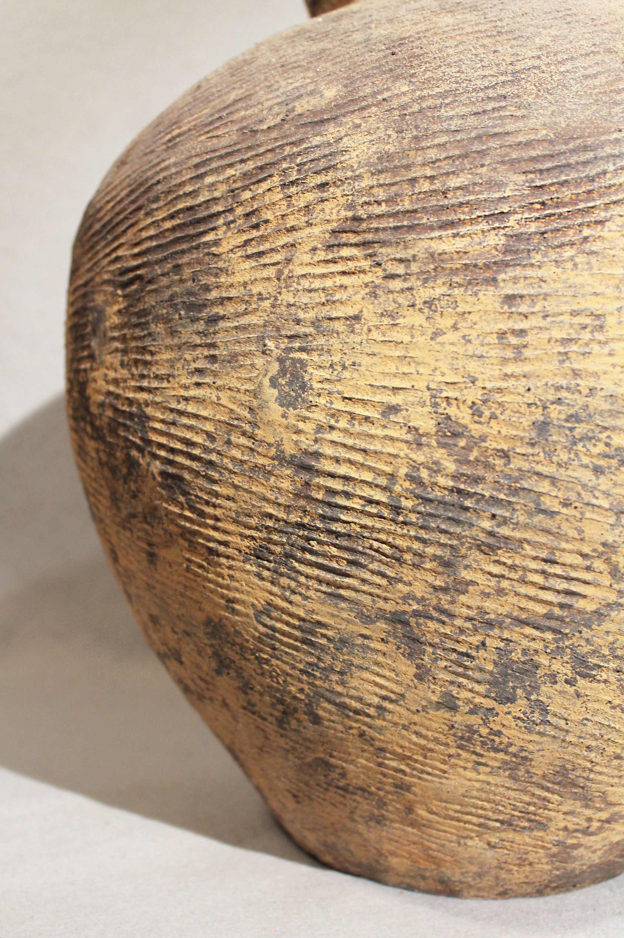 A Chinese grey-ware pottery large compressed jar with grooved ...