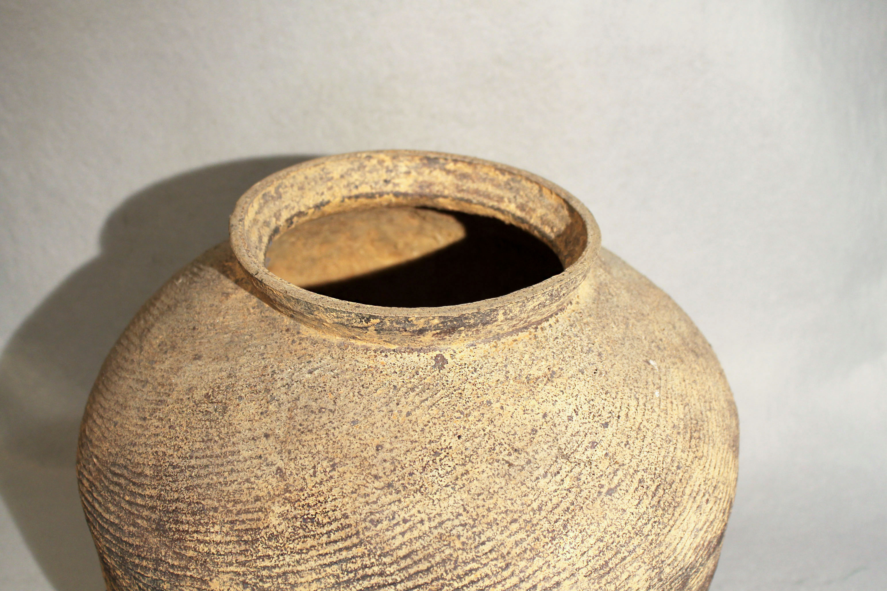 A Chinese grey-ware pottery large compressed jar with grooved ...