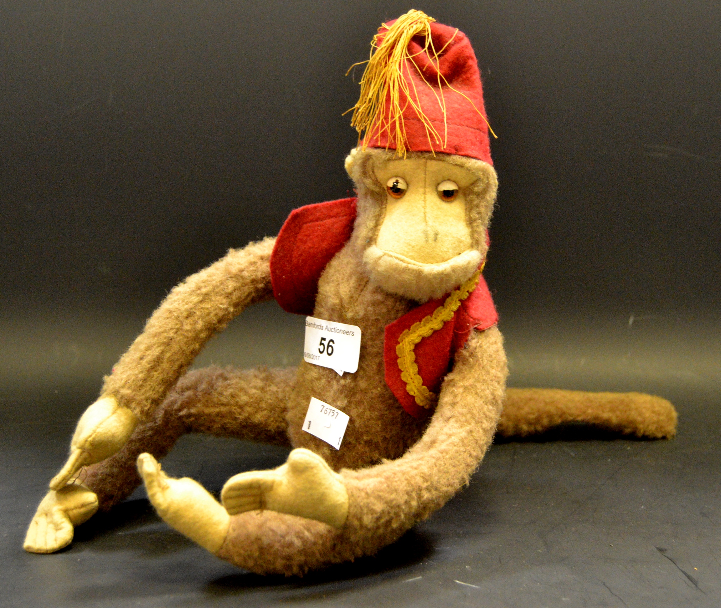 Toy - stuffed monkey dressed in a waistcoat and fez, c.1930's