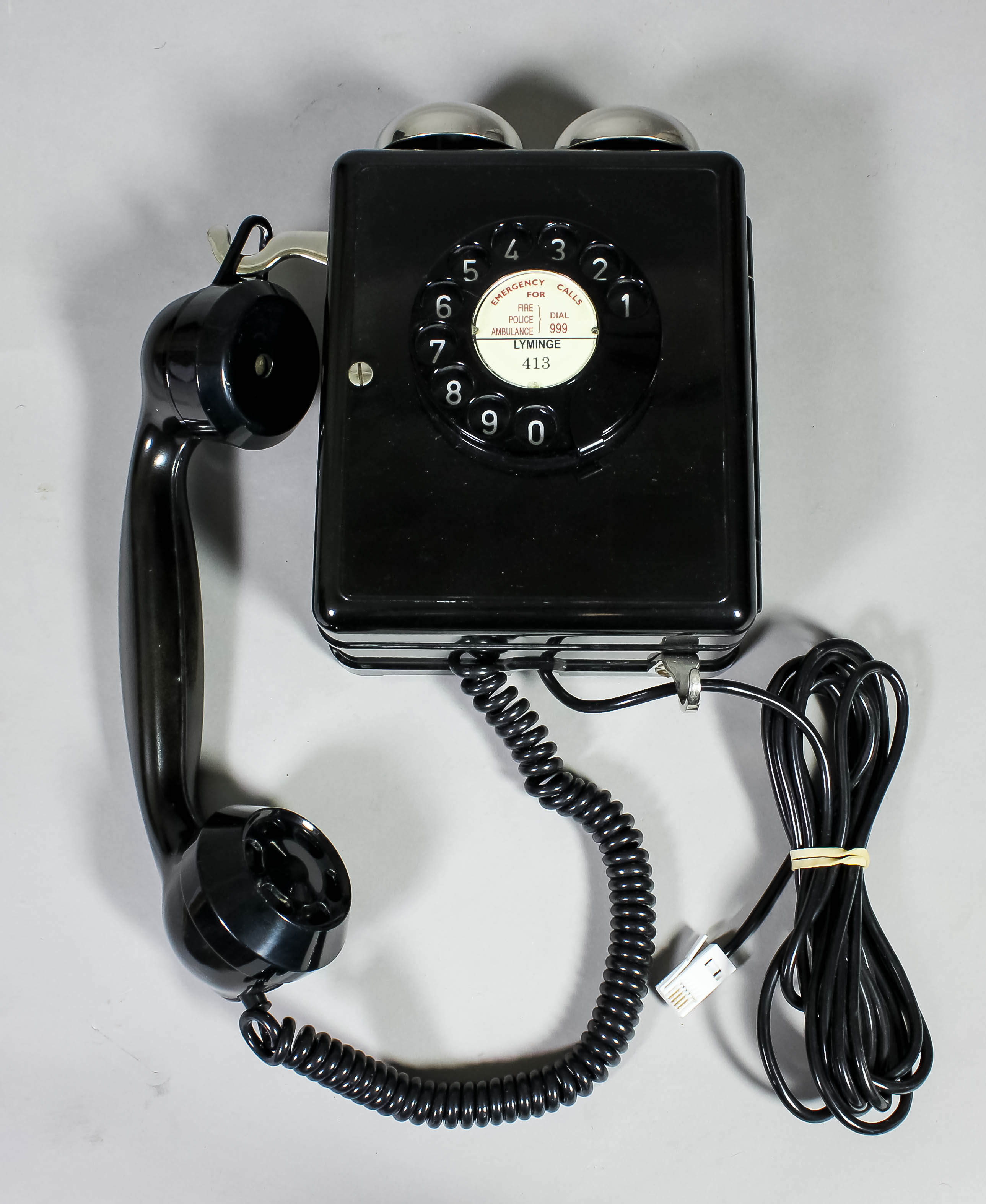 A 1950s Swiss black Bakelite wall mounted telephone with twin bells ...