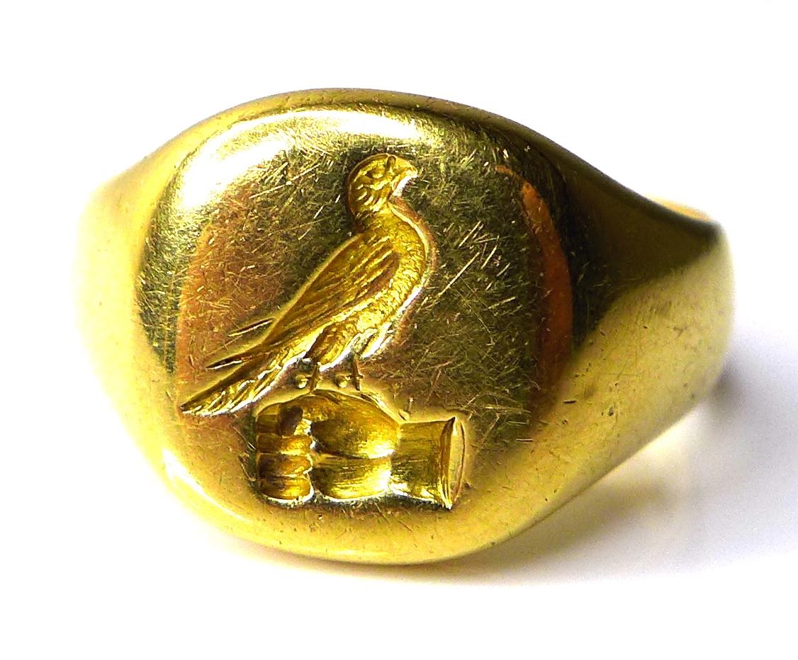 A Victorian 18ct gold signet ring, with engraved bird in hand ...