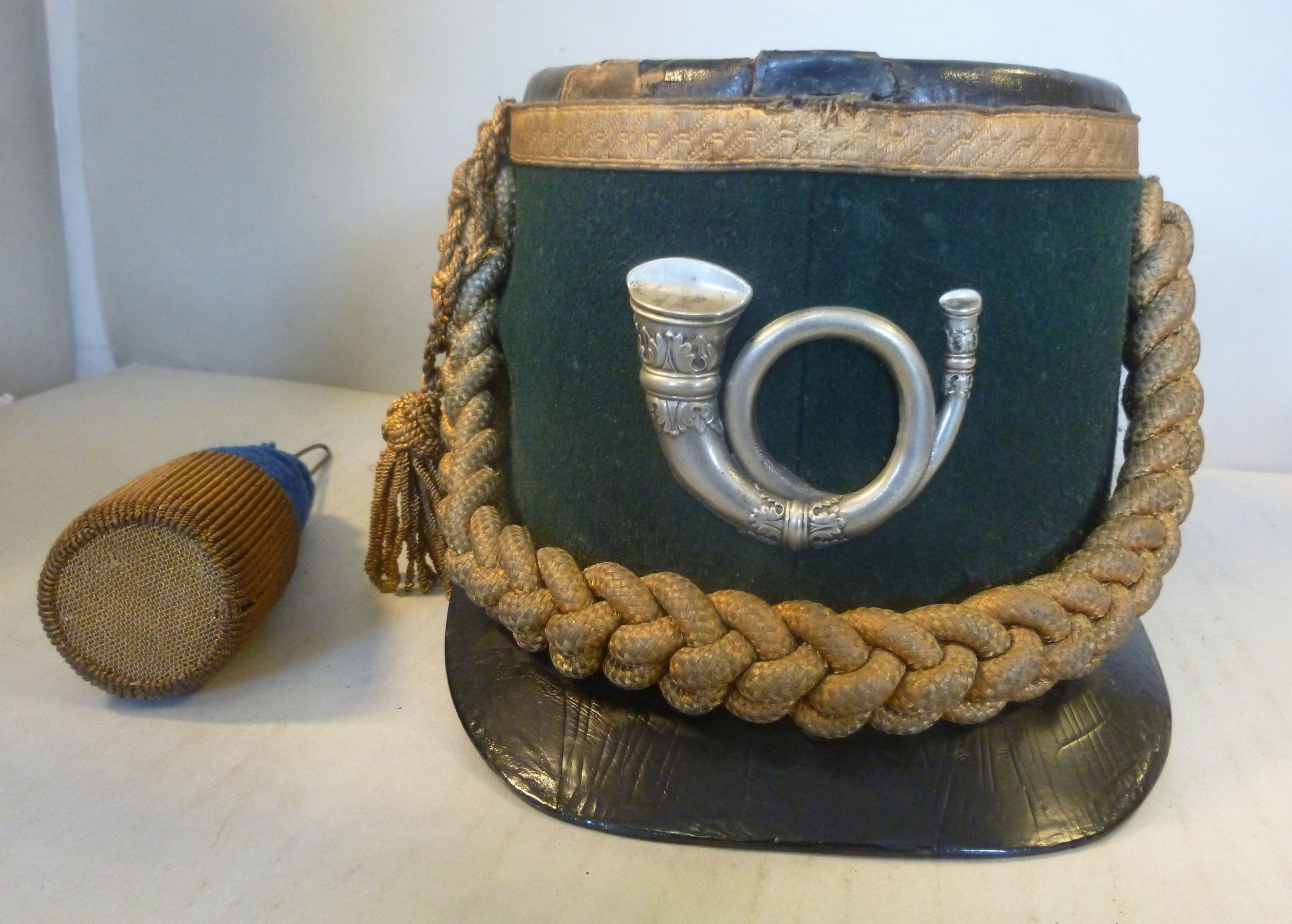 A 19thC style military shako, in a black painted tinplate box