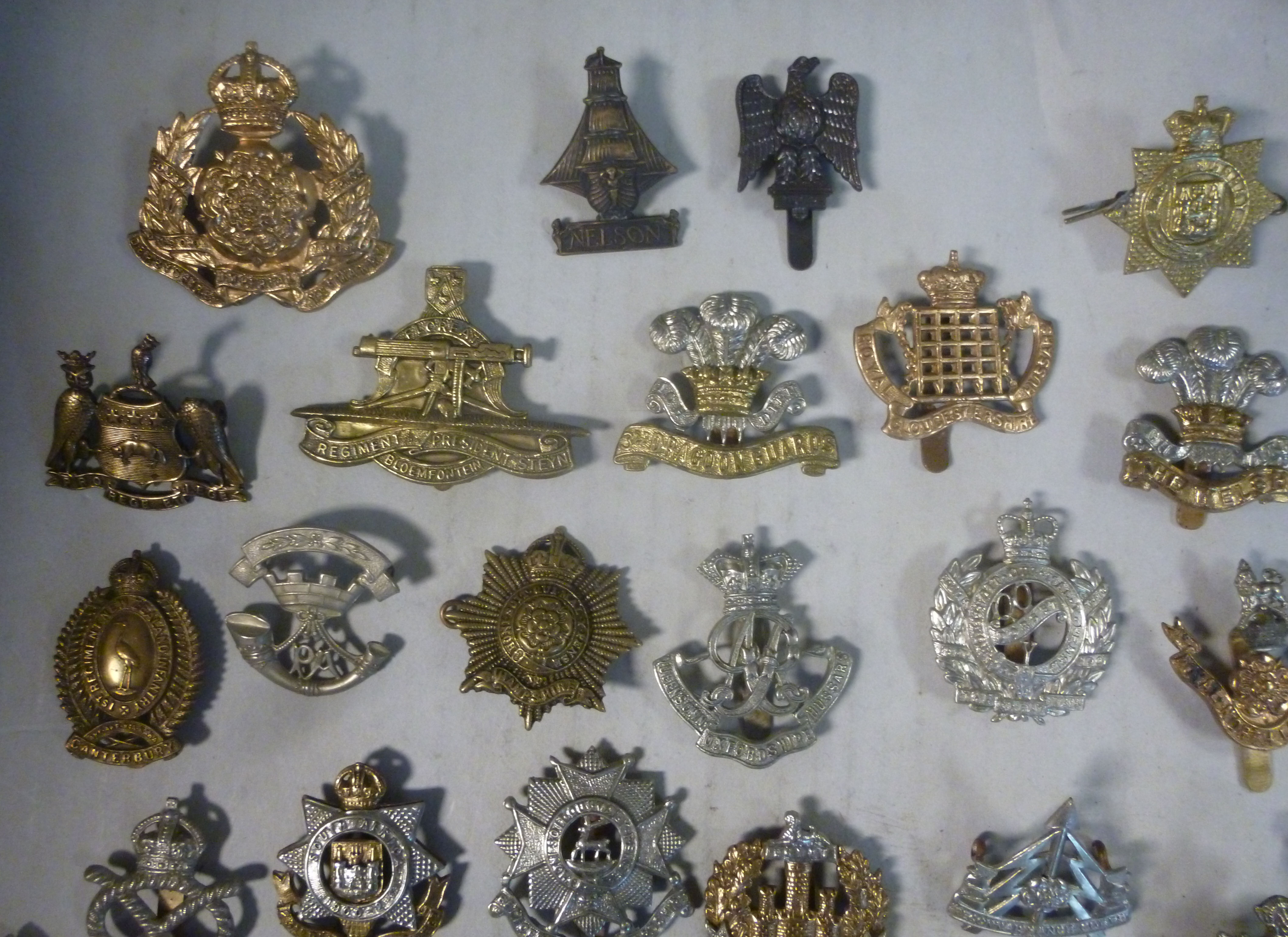 A collection of mainly British regimental and other badges and insignia ...