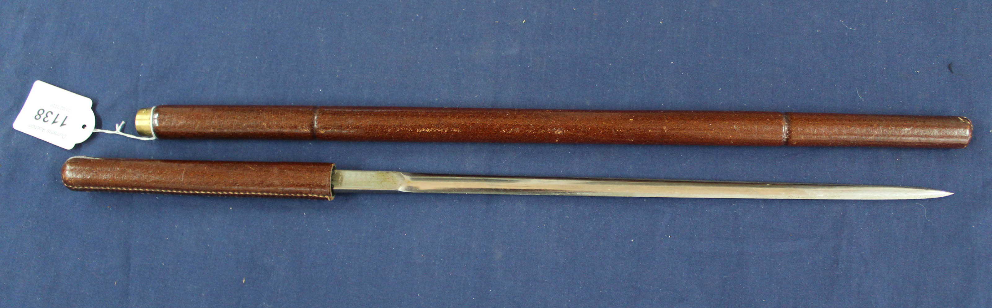 A very fine leather covered swagger stick with concealed etched blade ...
