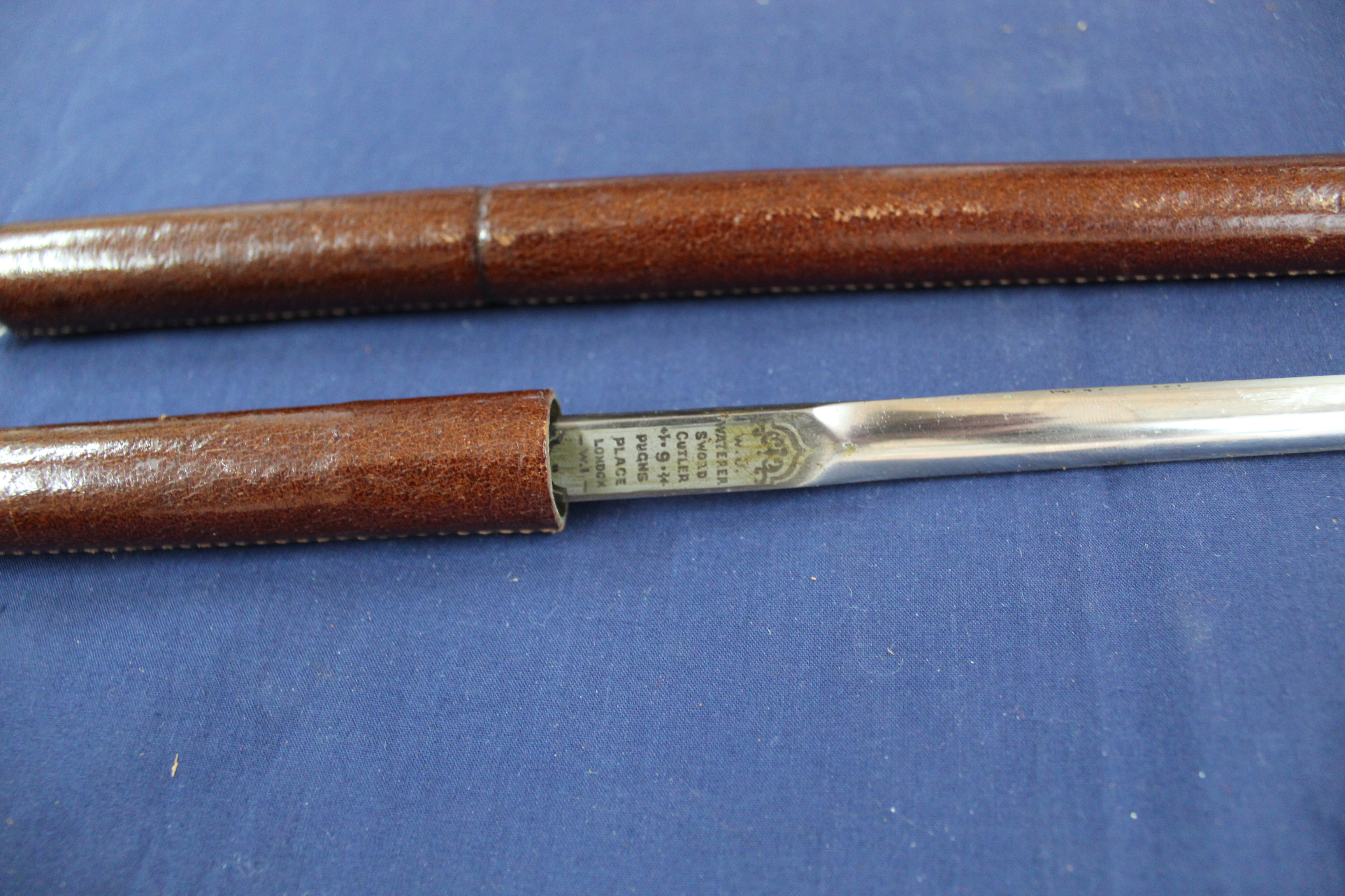 A very fine leather covered swagger stick with concealed etched blade ...