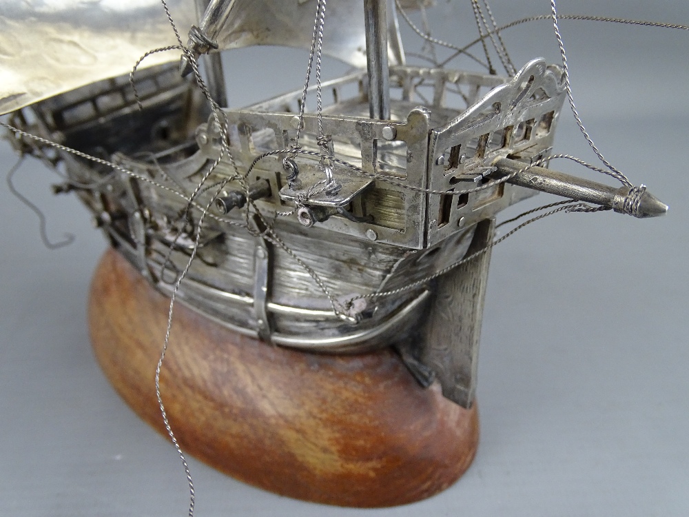 A PORTUGUESE SILVER GALLEON mounted on a wooden base, stamped to the ...