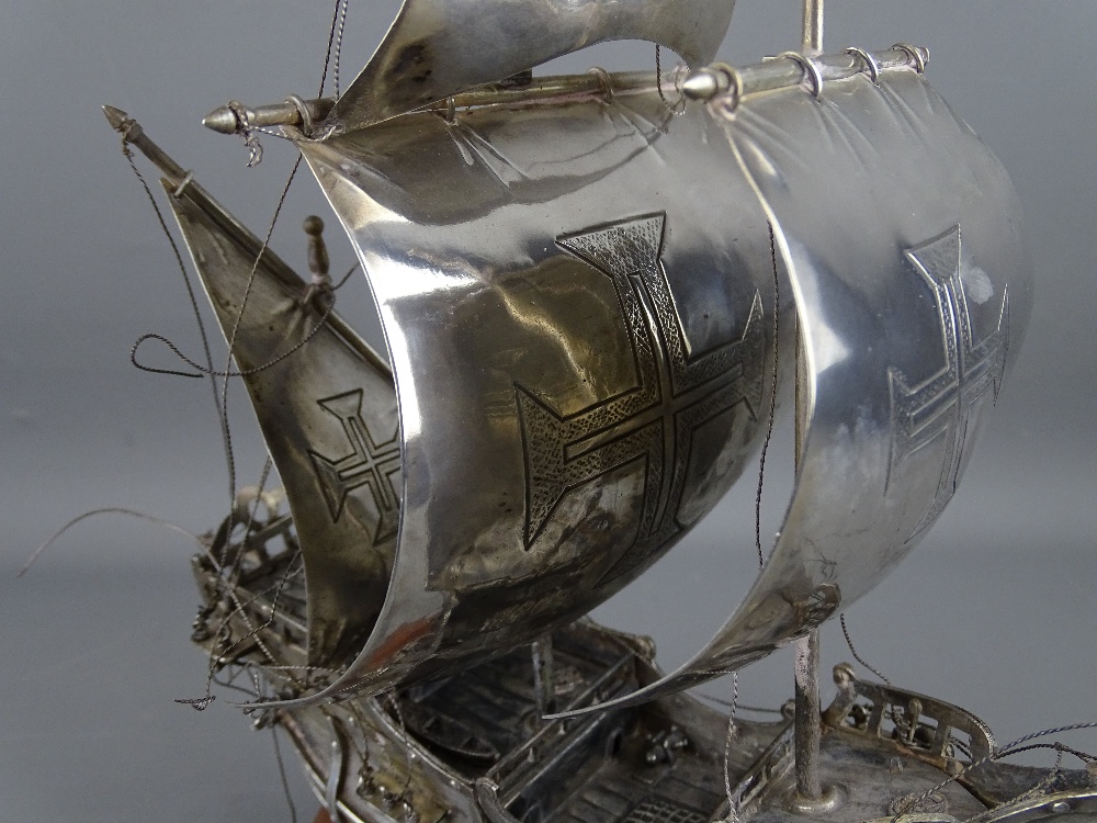 A PORTUGUESE SILVER GALLEON mounted on a wooden base, stamped to the ...