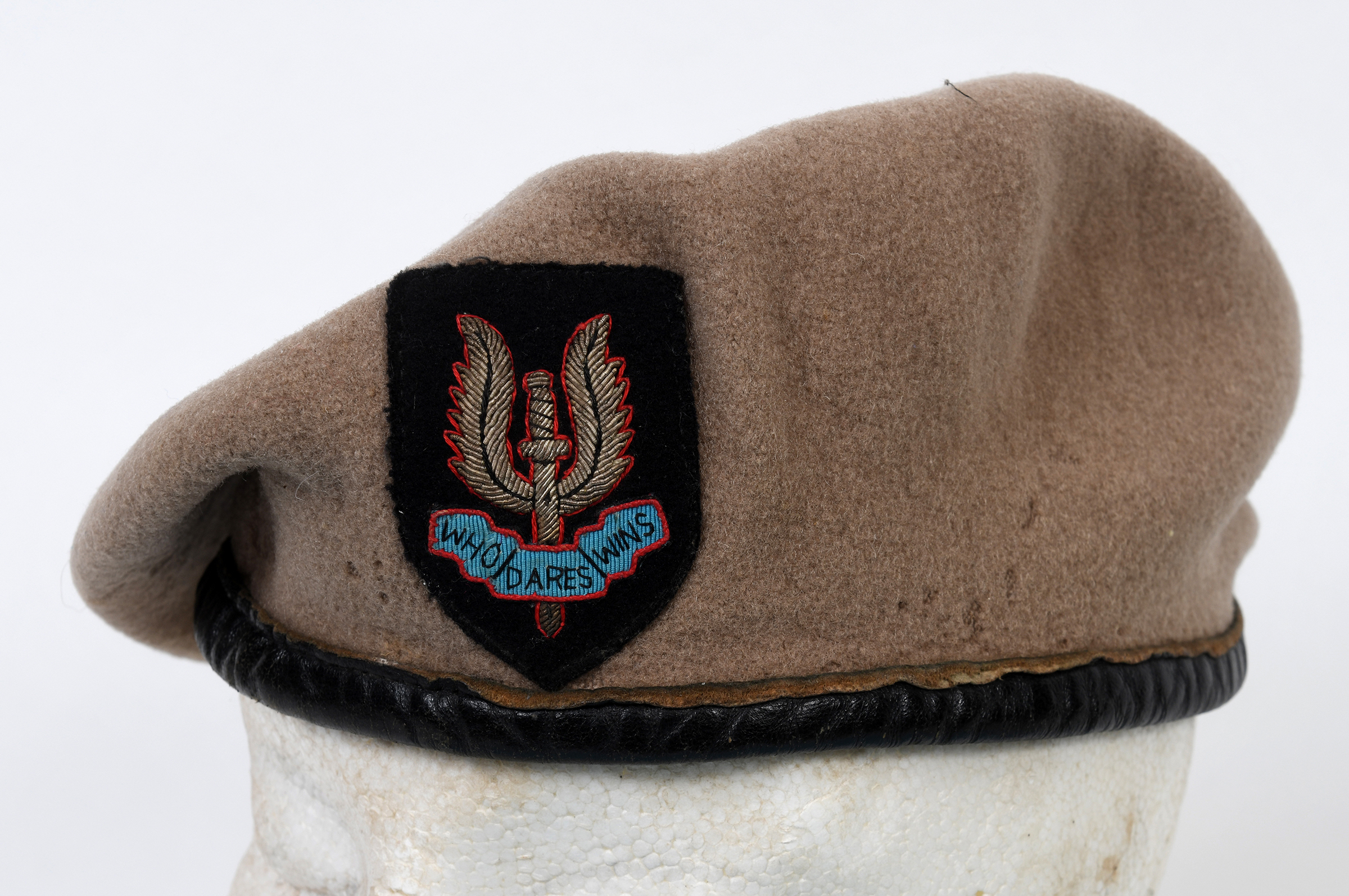 A Special Air Service Regiment sand coloured beret, with a black ...