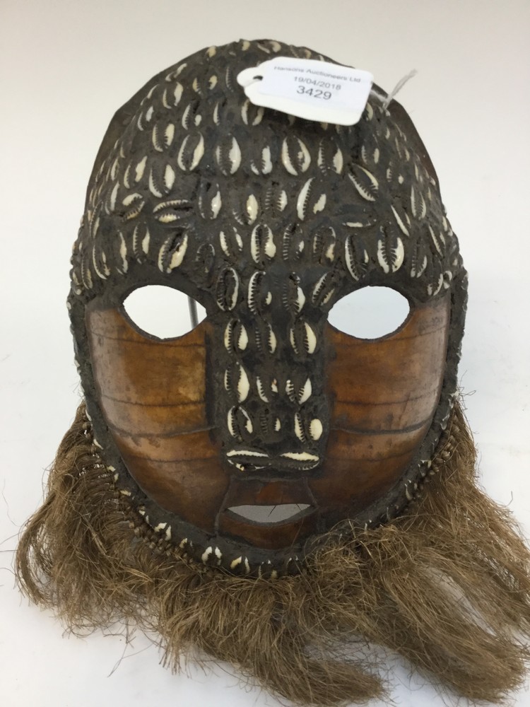A West African tribal turtle and cowrie shell mask, probably Lega, late ...