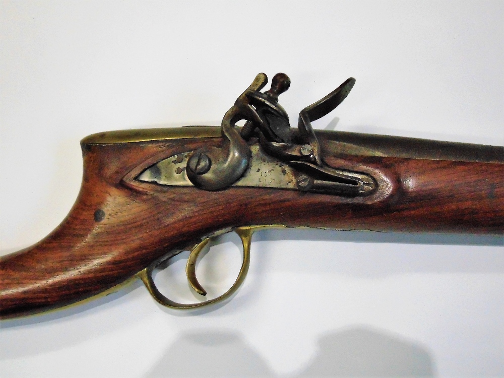 A Turkish flintlock rifle in rosewood with applied brass detail