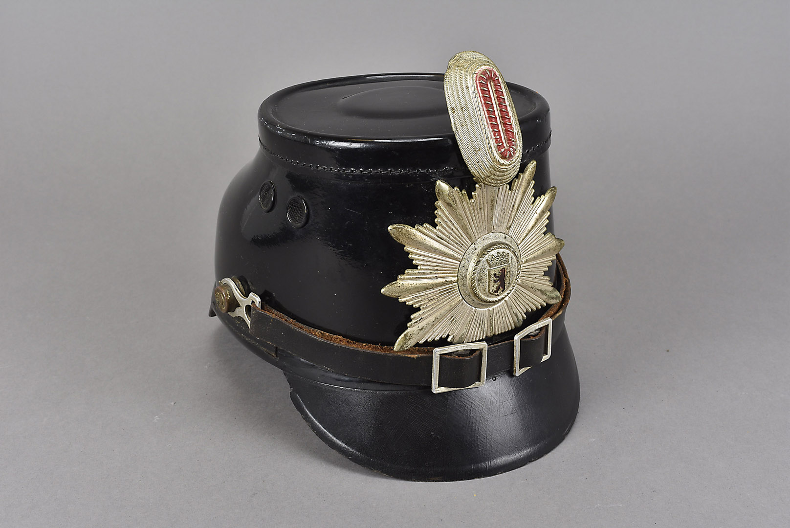 A 1940s German Police Tschako helmet, marked Berolina to inside, with liner