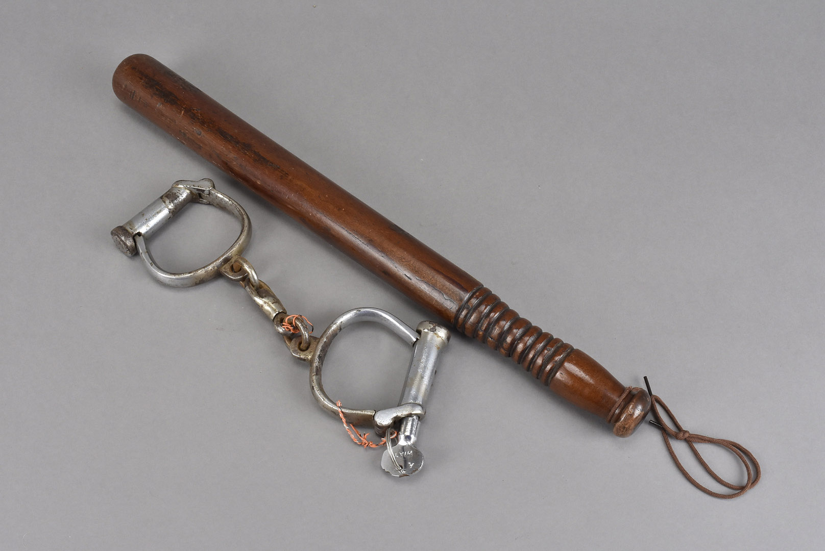 A vintage Military Police wooden truncheon, marked with Crown and MP ...