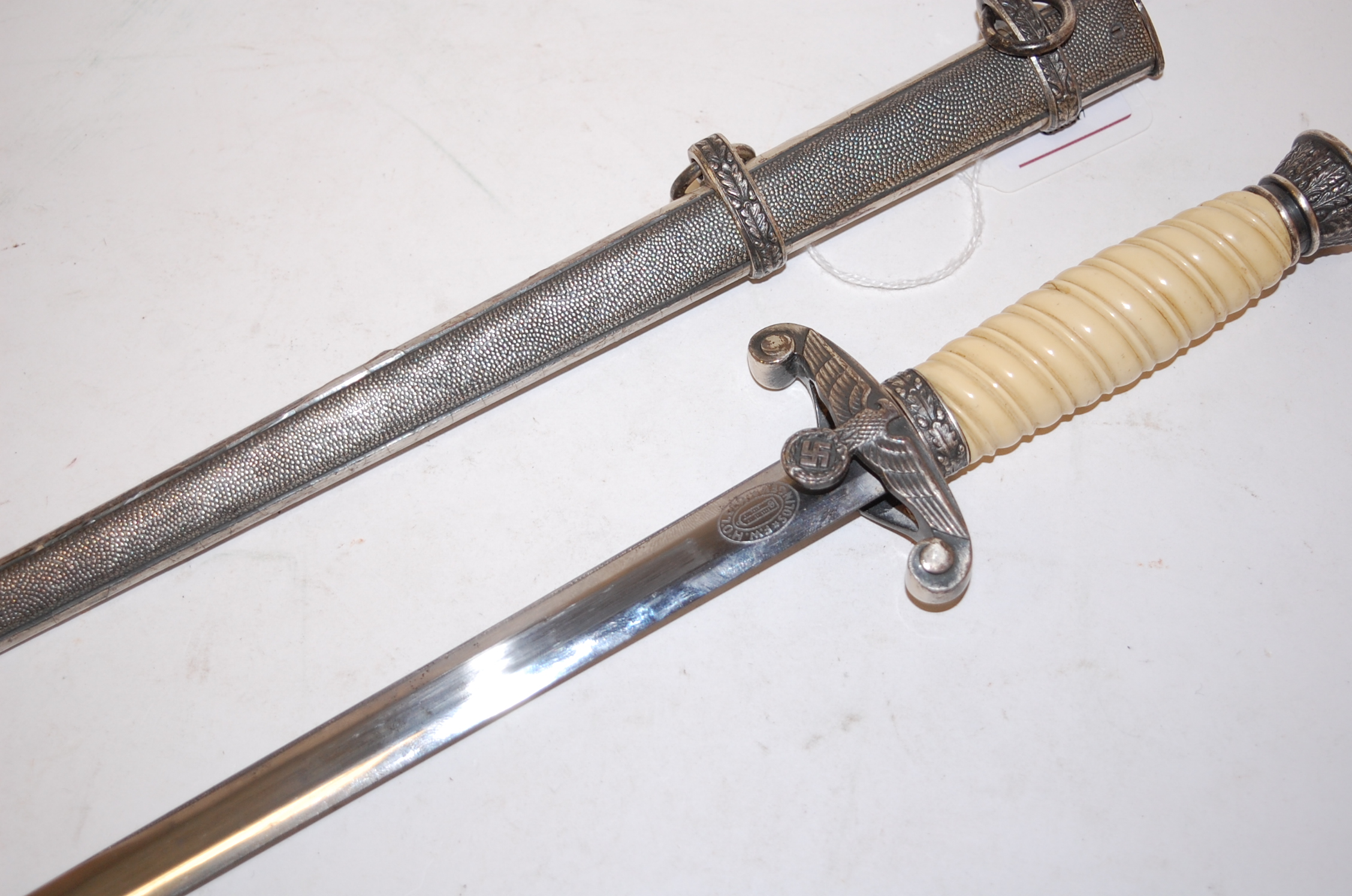 A reproduction German dress dagger, the 23.3cm double edge blade ...