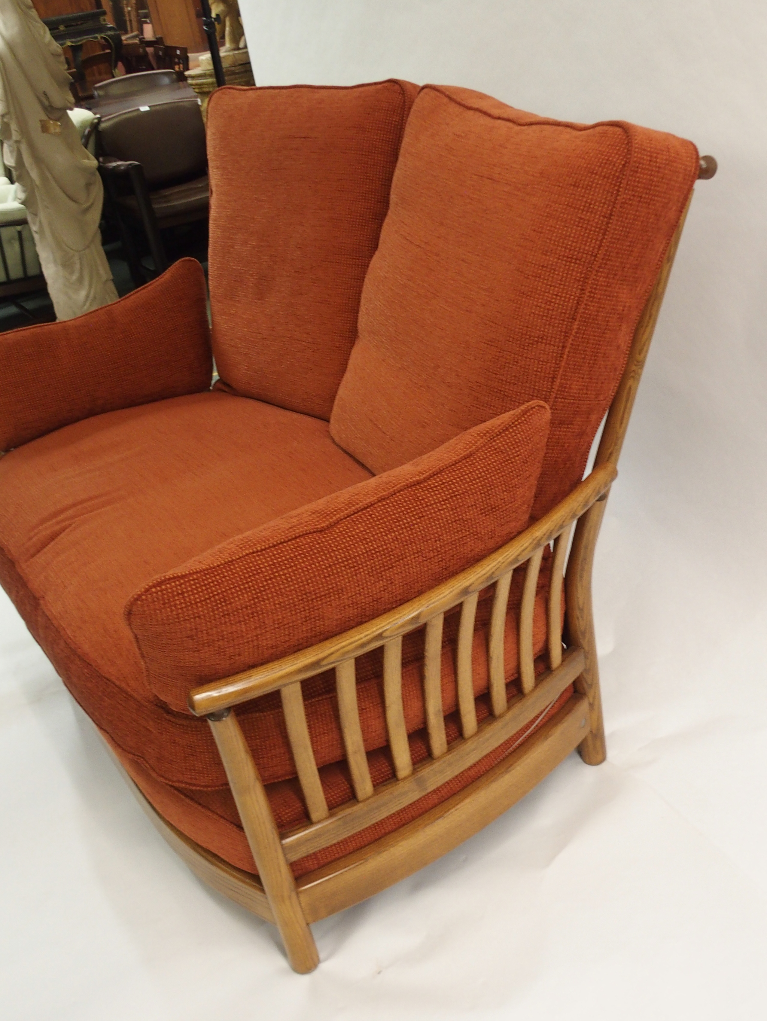 AN ERCOL RENAISSANCE TERRACOTTA UPHOLSTERED THREE PIECE SUITE ...