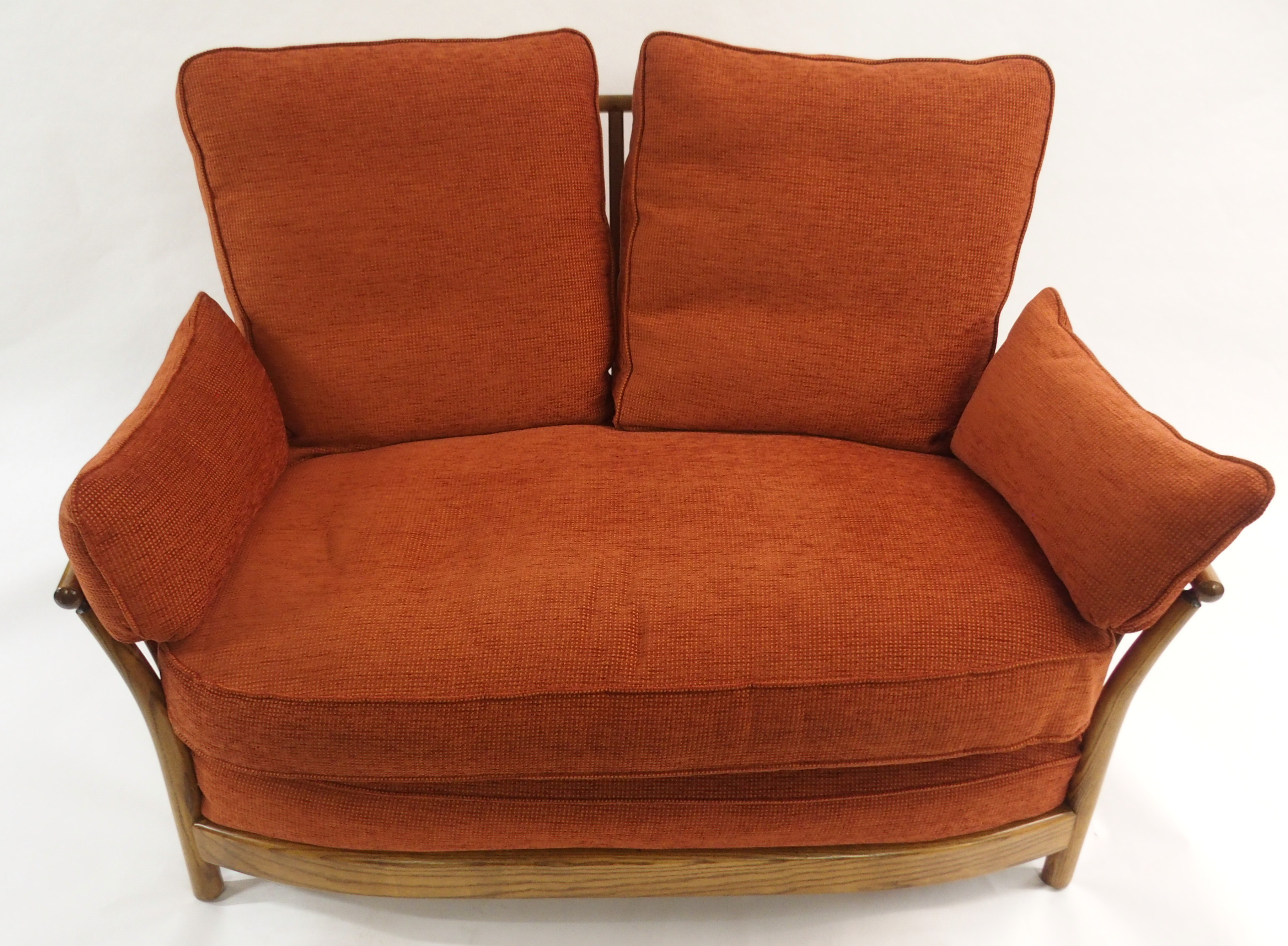 AN ERCOL RENAISSANCE TERRACOTTA UPHOLSTERED THREE PIECE SUITE ...