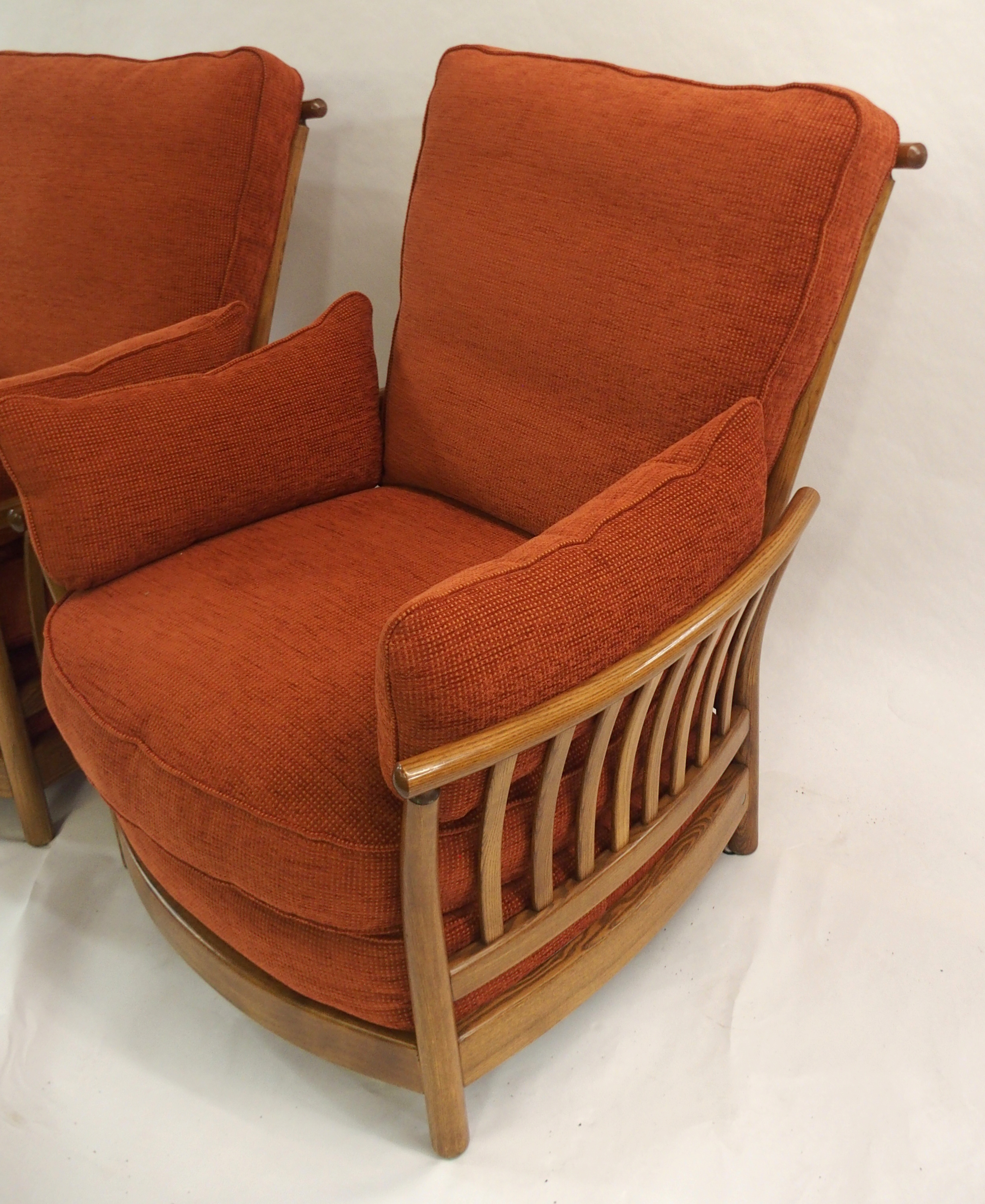 AN ERCOL RENAISSANCE TERRACOTTA UPHOLSTERED THREE PIECE SUITE ...