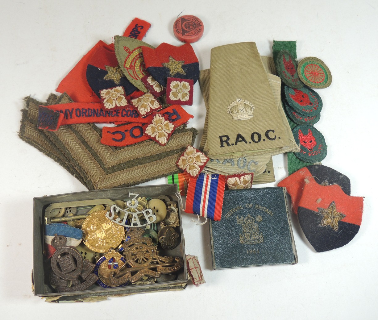 A quantity of military cloth badges; RAOC epaulettes; metal badges and ...