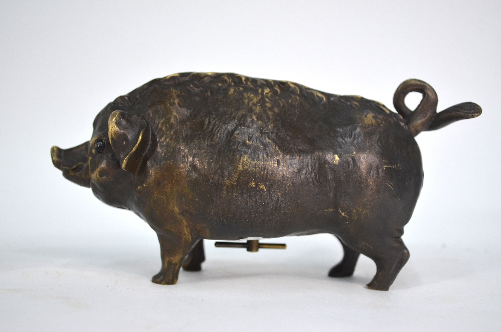 A bronze novelty 'pig' counter-bell with clockwork movement, 17 cm long ...