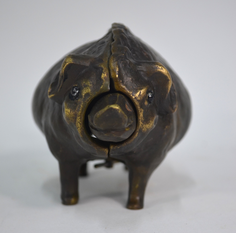 A bronze novelty 'pig' counter-bell with clockwork movement, 17 cm long ...