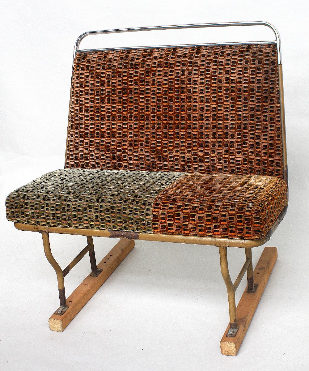 A Routemaster bus chrome passenger seat, upholstered in uncut moquette ...