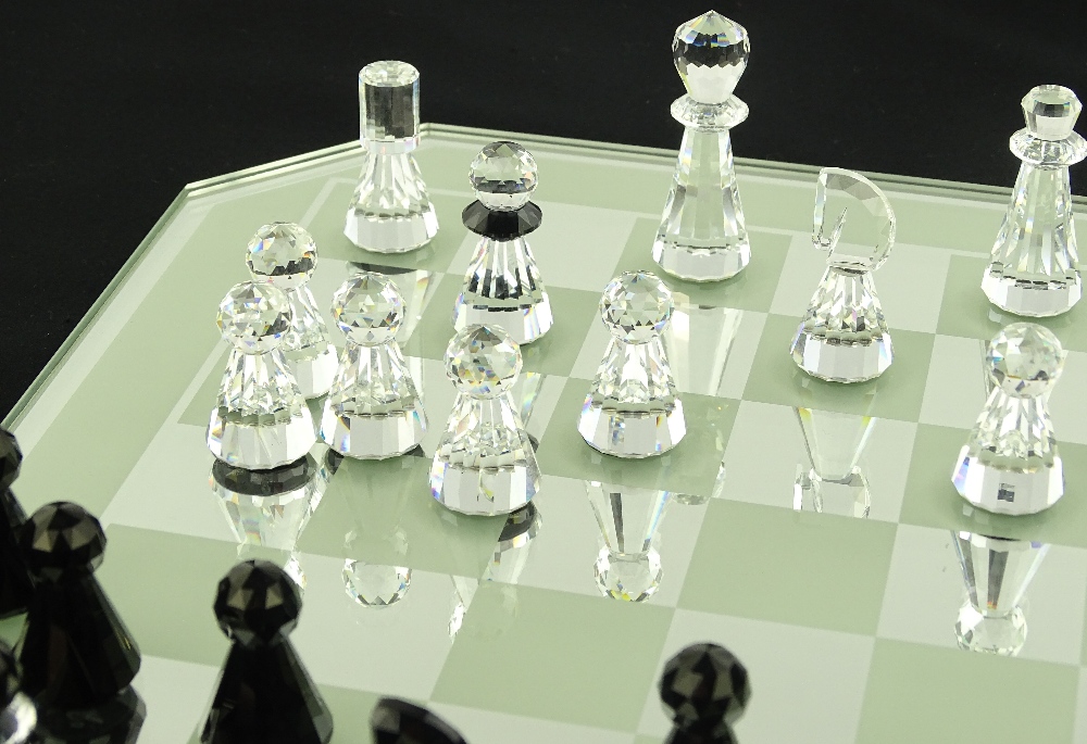 A Swarovski silver crystal chess set and board, cased.