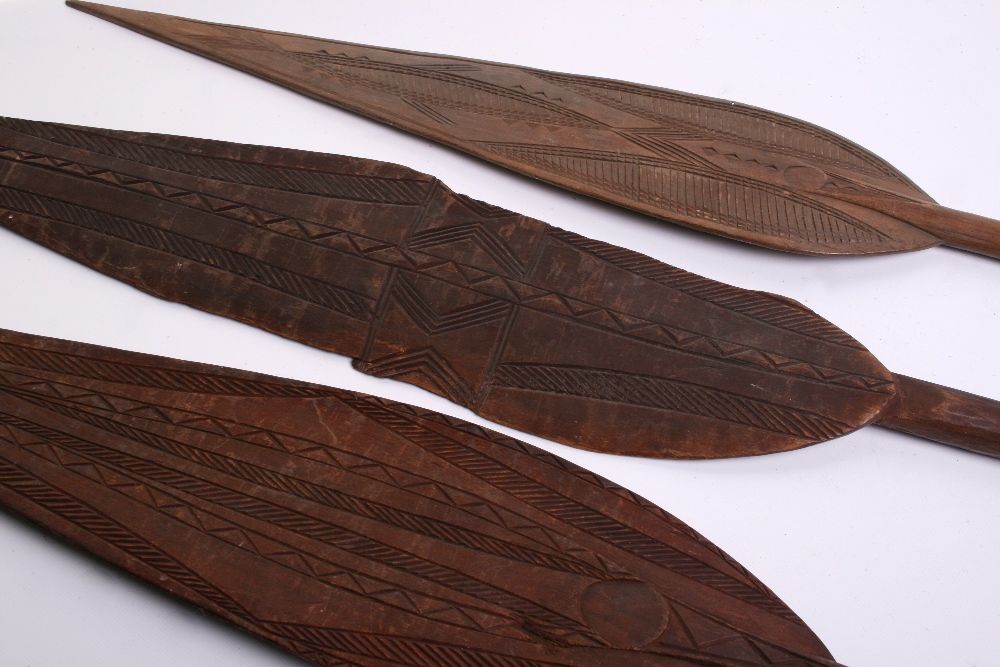 Three Assorted West African Carved Wooden Paddles, maximum 66.5"overall ...