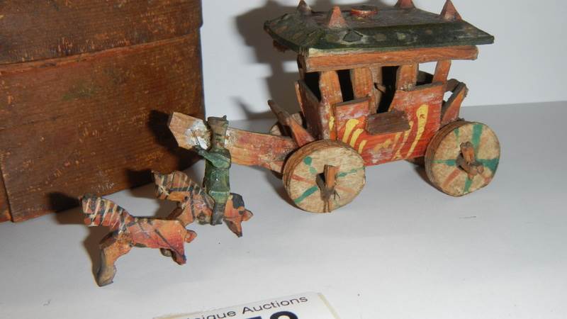 A late 18th century wooden toy of a circus cage carriage with figures ...