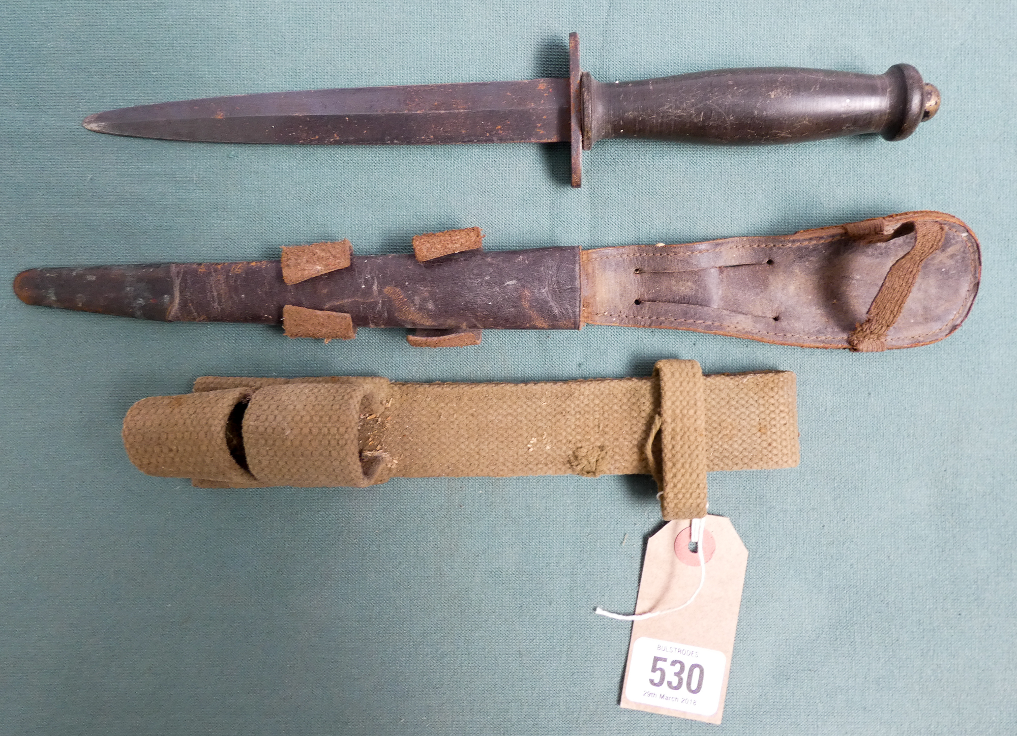 British army commando dagger complete with its leather scabbard and ...