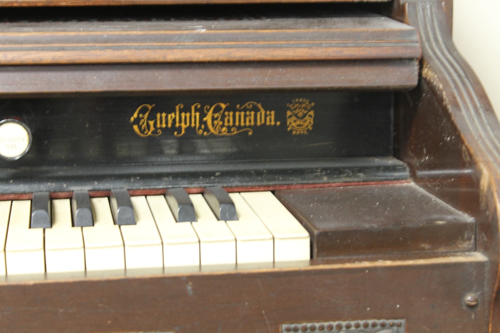 AN EARLY 20TH CENTURY BELLOWS ORGAN BY 'BELL ORGAN AND PIANO CO. LTD ...