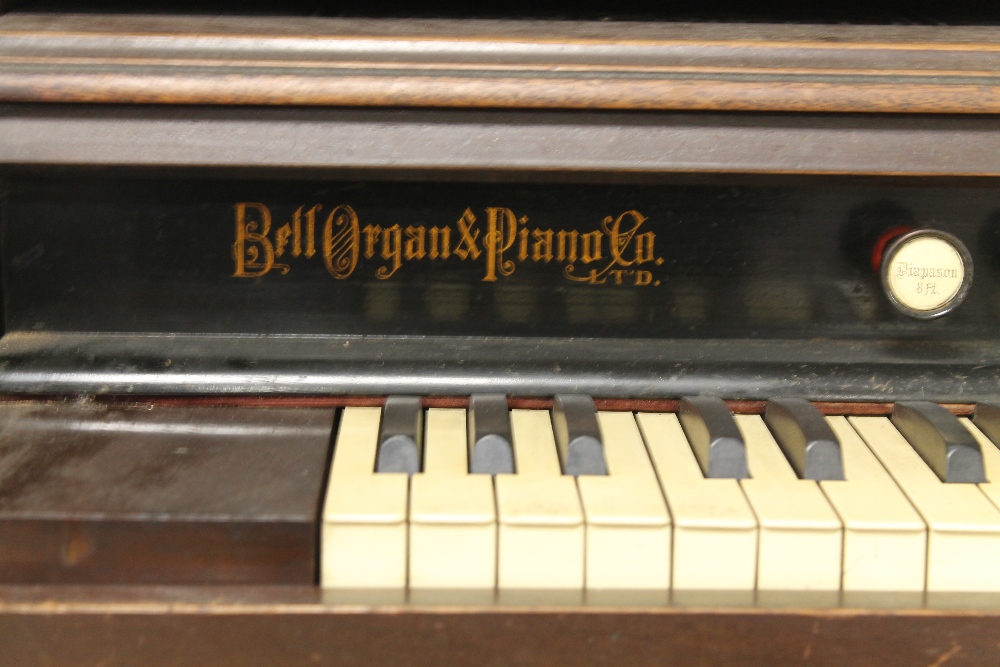 AN EARLY 20TH CENTURY BELLOWS ORGAN BY 'BELL ORGAN AND PIANO CO. LTD ...