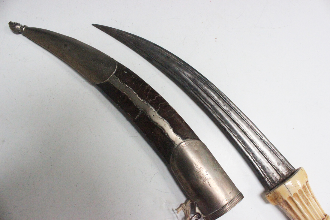 A Middle Eastern jambia with curved double edged blade with central ...