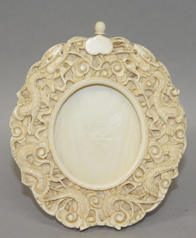 A 19TH/20TH CENTURY CHINESE IVORY OVAL PICTURE FRAME, circa 1900, the ...