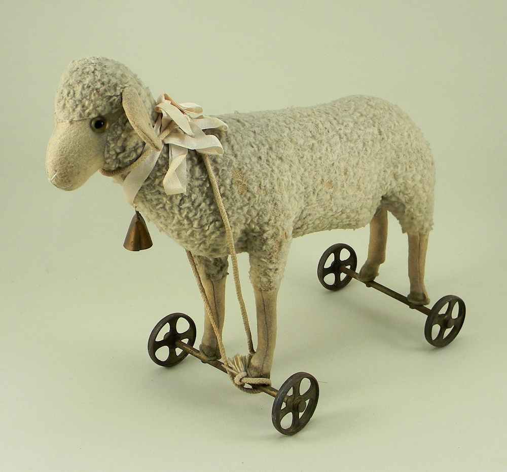 A Steiff wool plush Lamb on wheels, circa 1920, button to left ear ...