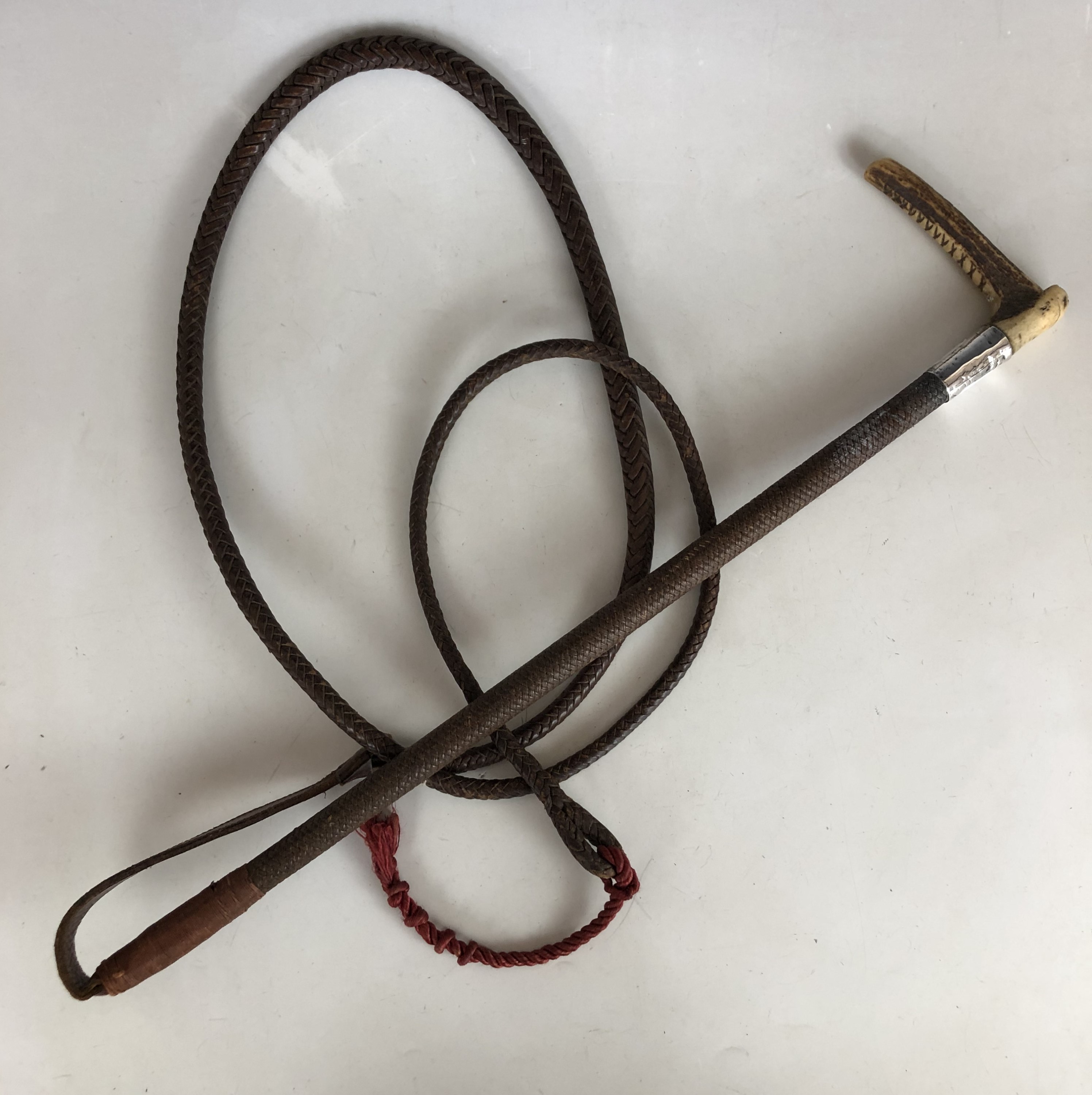 A late 19th century silver-mounted and horn-handled leather riding whip ...