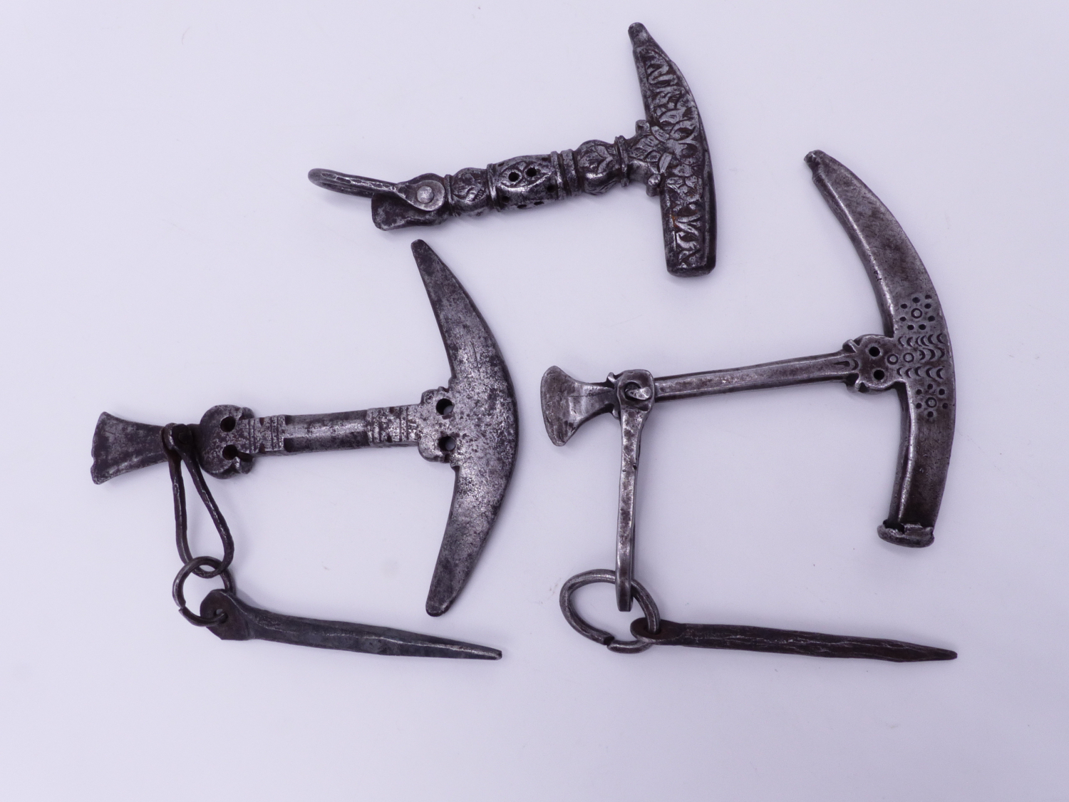 THREE IRON FLINT KNAPPING HAMMERS, TWO WITH CARVED AND ENGRAVED ...