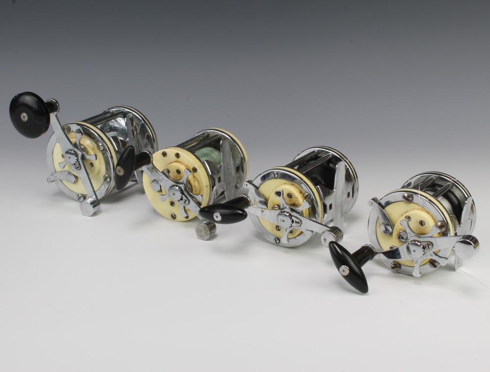 A Mitchell 624 sea multiplier fishing reel together with 3 other ...
