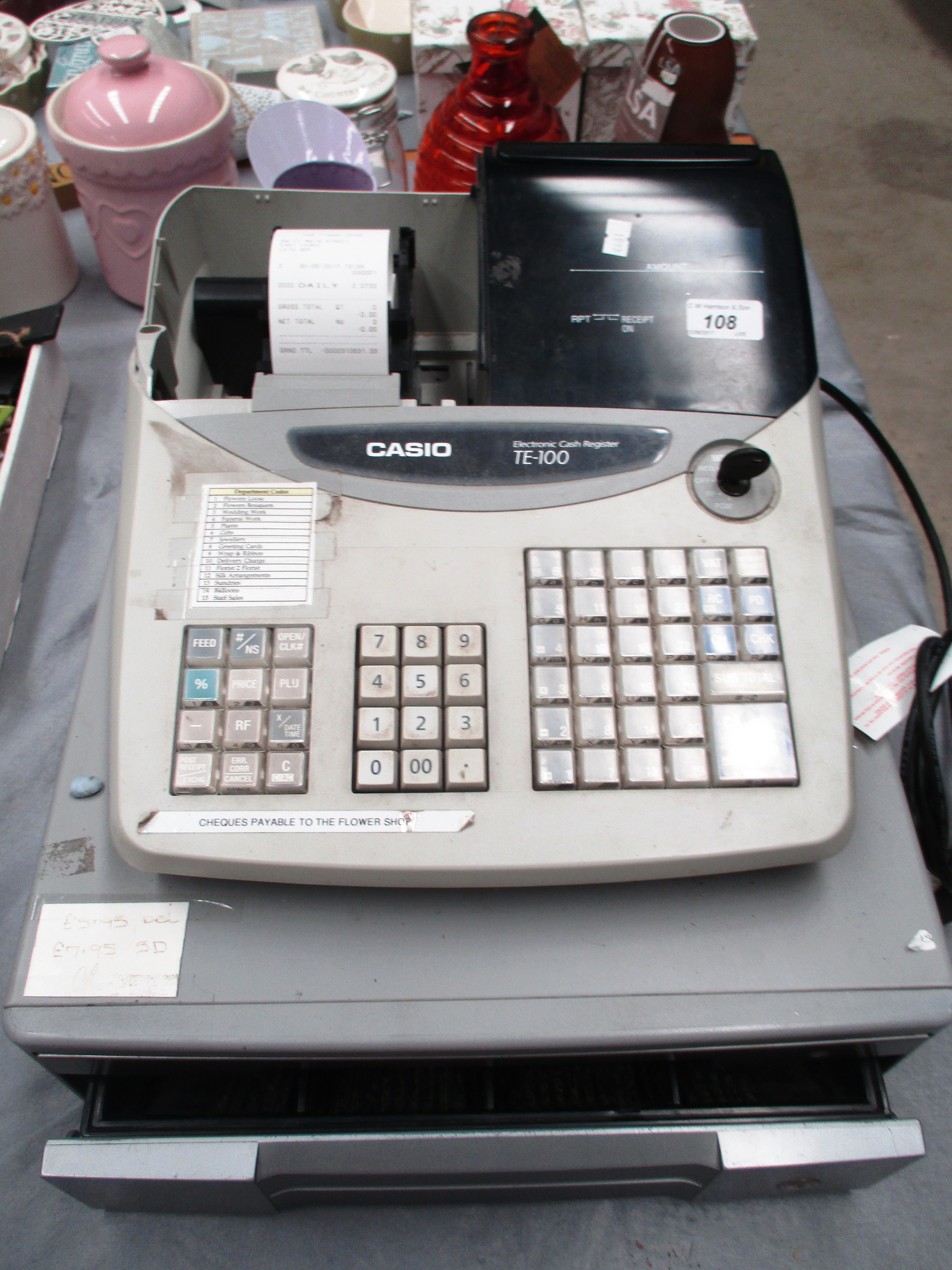 A Casio TE-100 electronic cash register with key