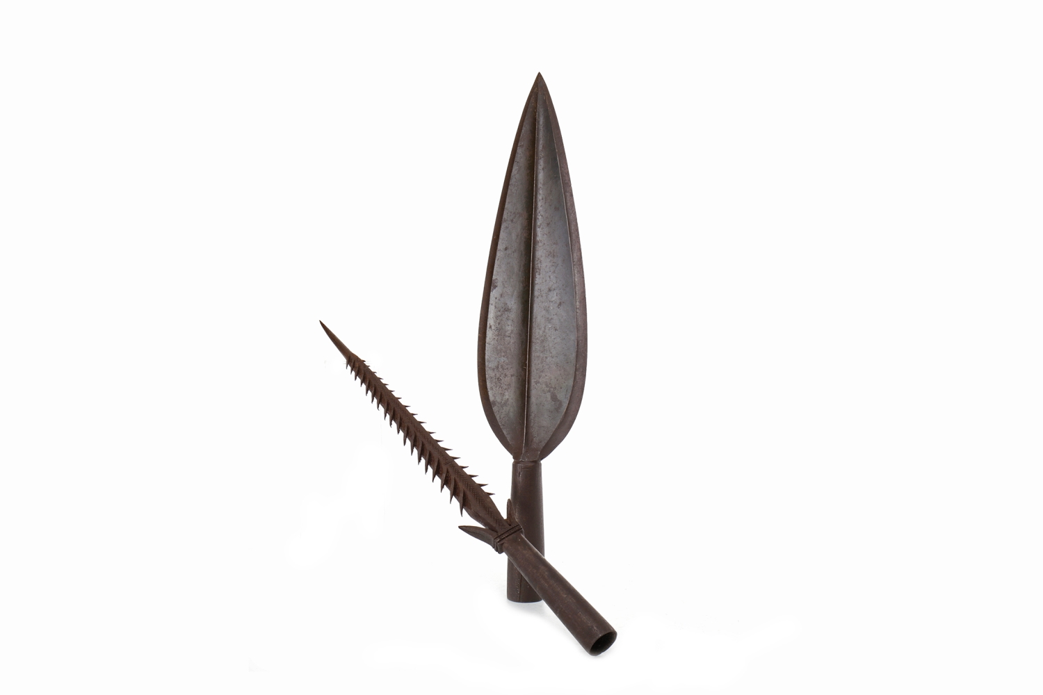 TWO EARLY 20TH CENTURY AFRICAN SPEAR HEADSone of jagged edge, 34cm long ...