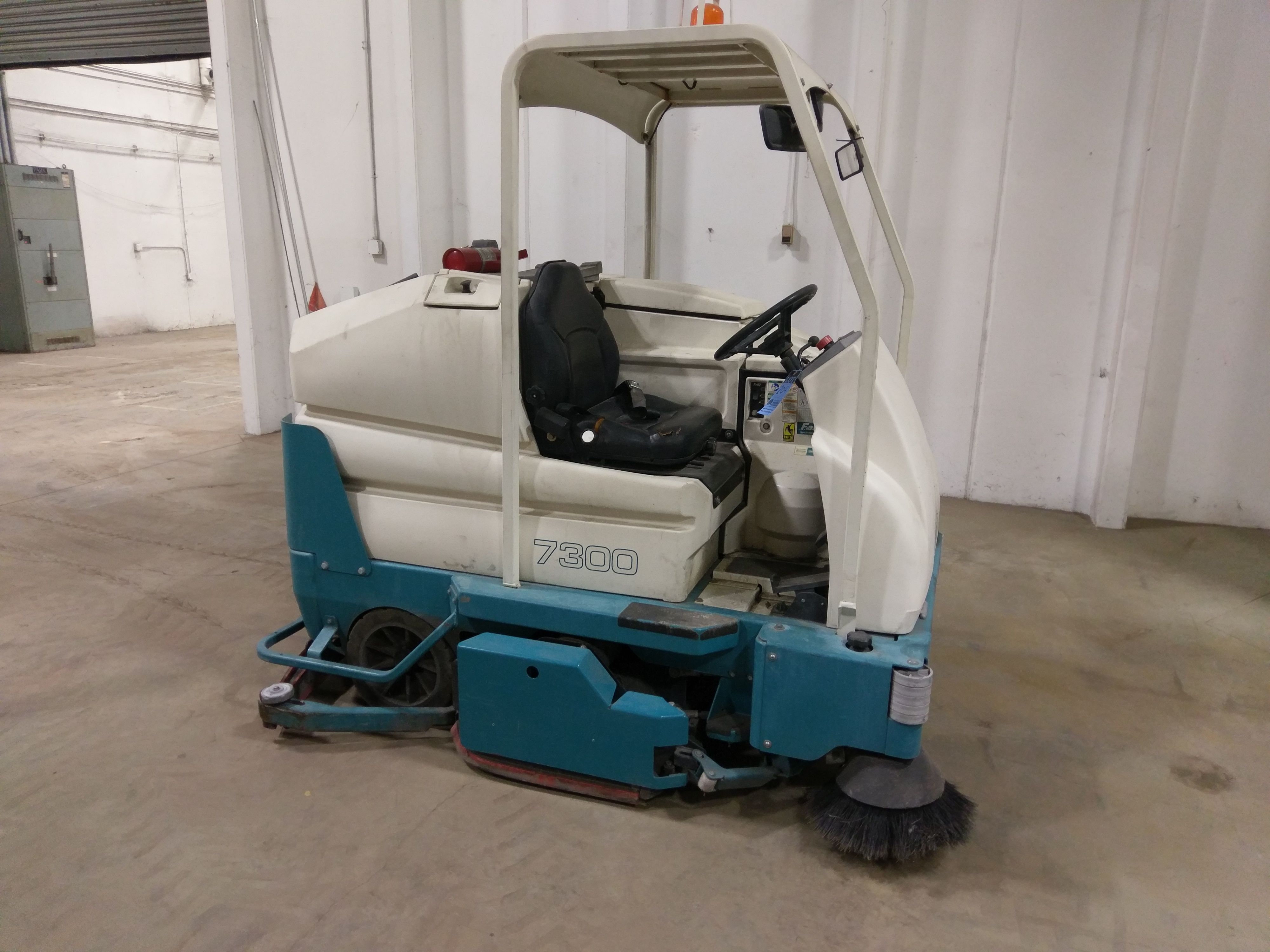 TENNANT MODEL 7300 ELECTRIC SIT DOWN FLOOR SCRUBBER / SWEEPER; S/N 7300 ...