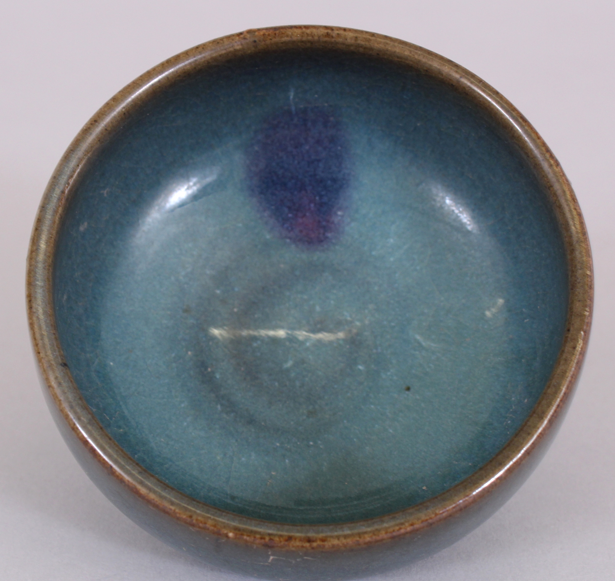 A CHINESE JUN WARE PURPLE SPLASH STONEWARE TEA BOWL, possibly Ming ...