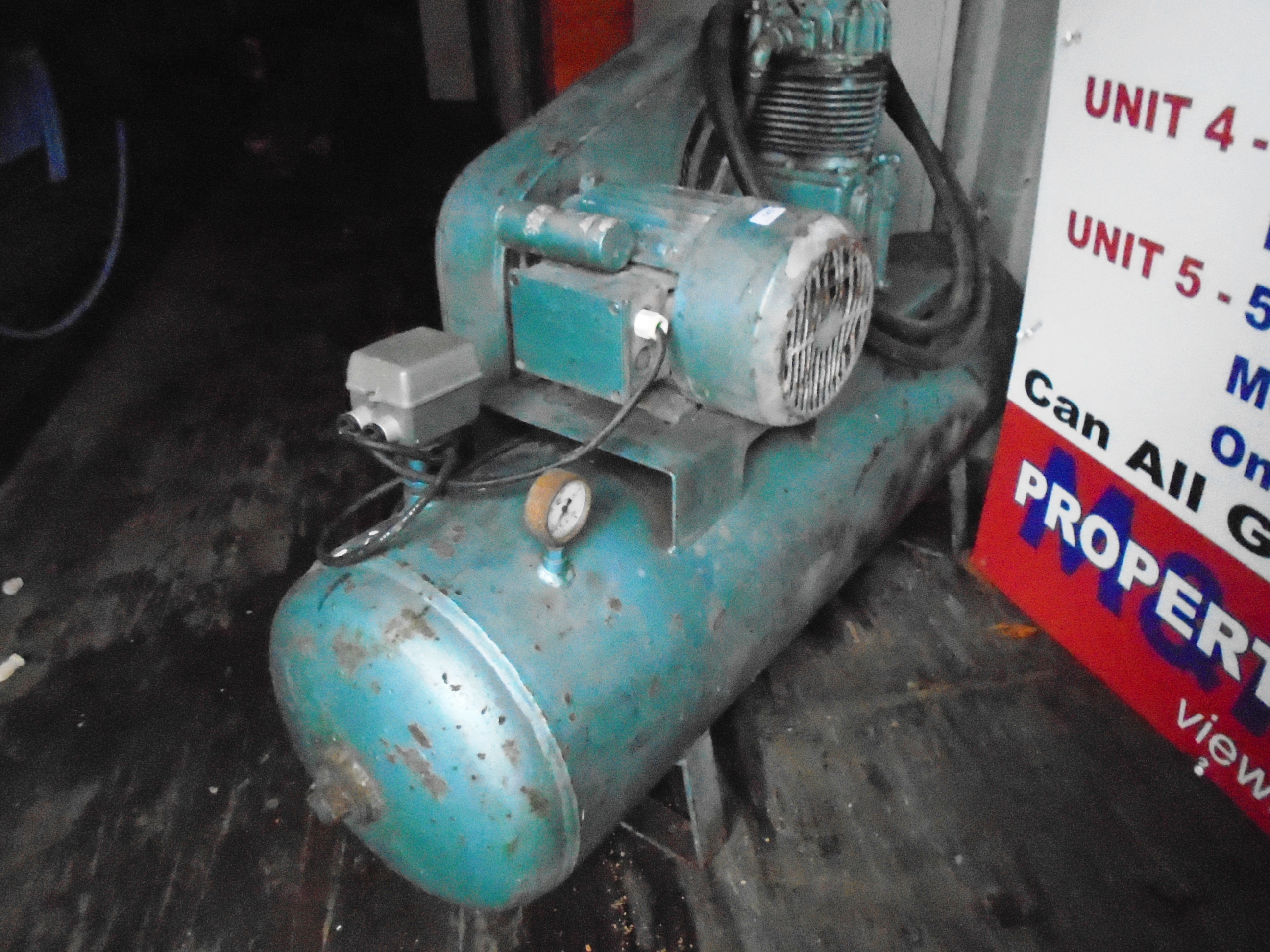 A green painted air compressor - single phase (flex cut off). PLEASE ...