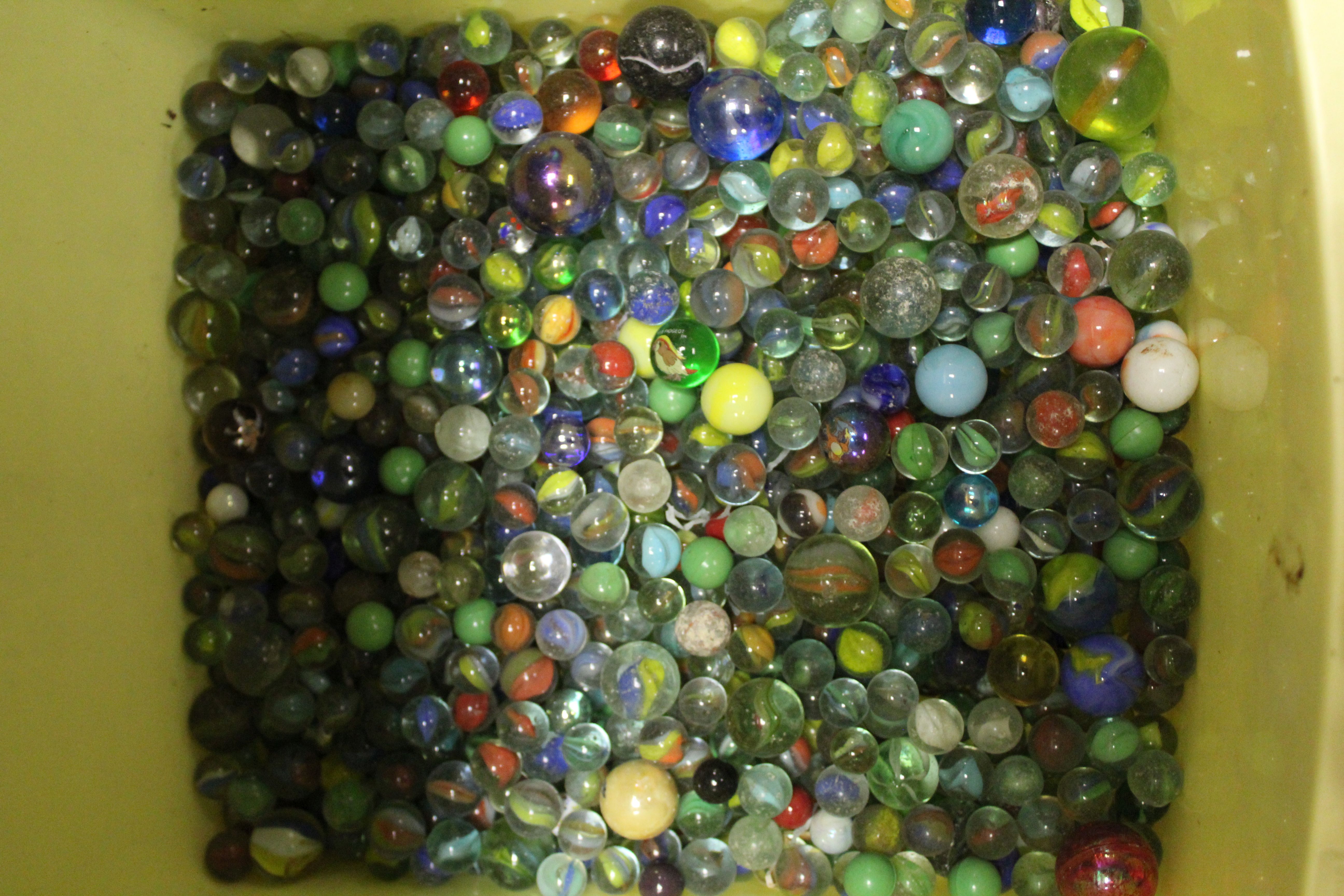 A large quantity of glass marbles in two boxes.
