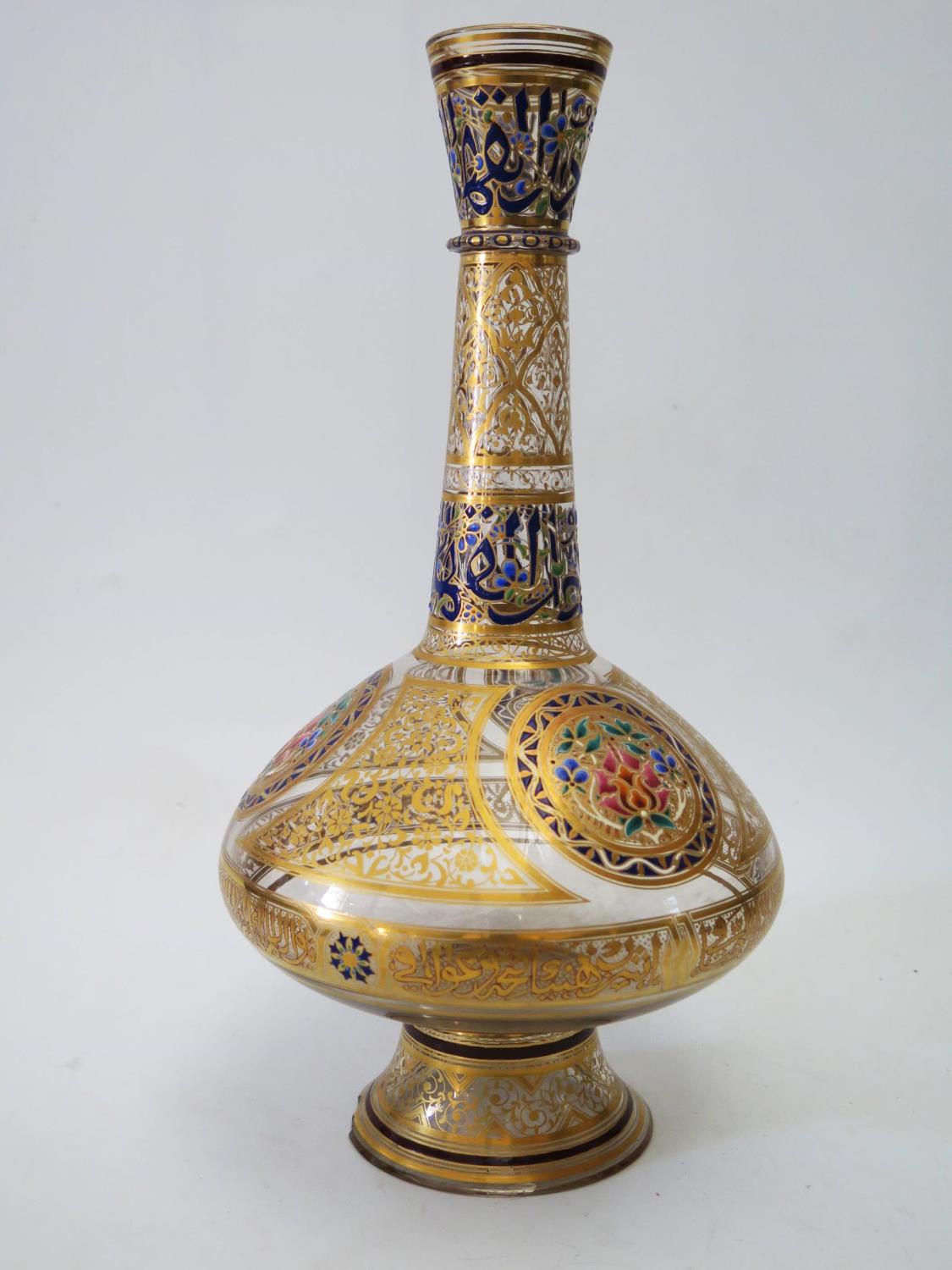 An Islamic Glass Vase decorated in enamels and gilt with script and ...