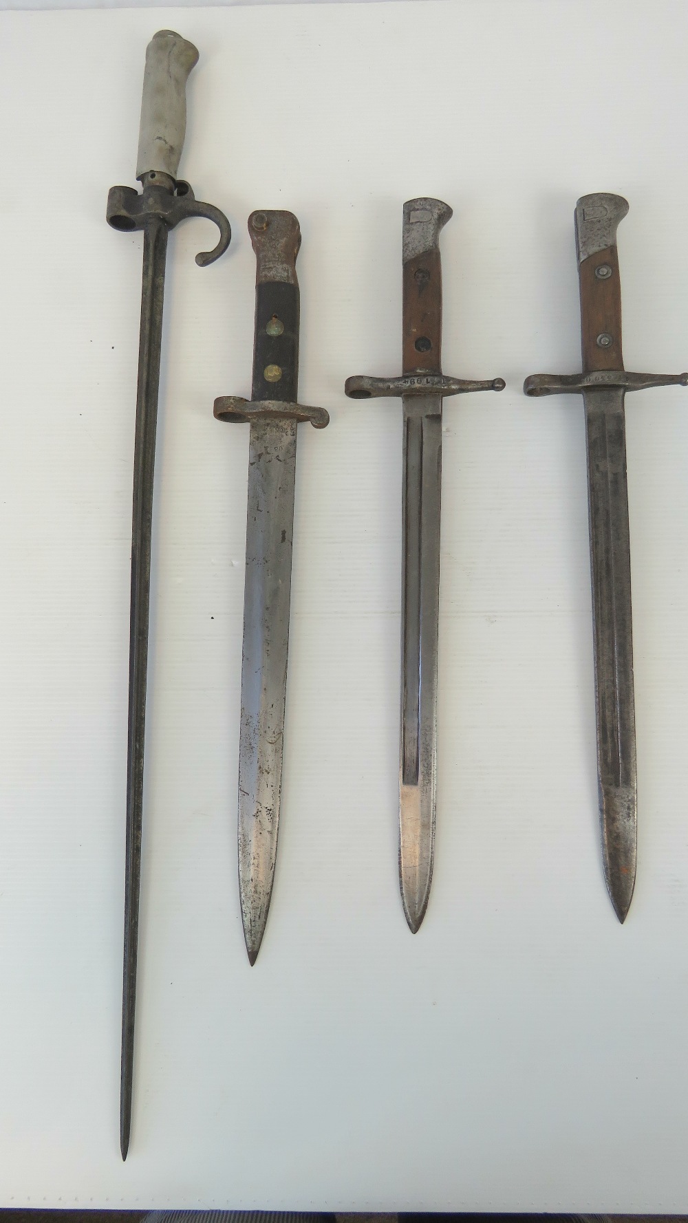 Four Military rifle bayonets; a British Long Lee WWI bayonet, a WWI ...