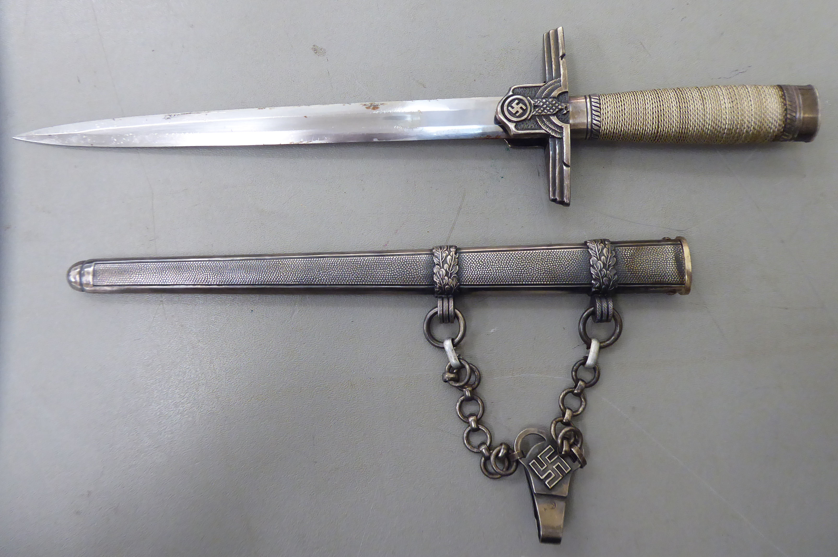 A German Hitler Youth Leader dagger, the wire bound handle with emblems ...