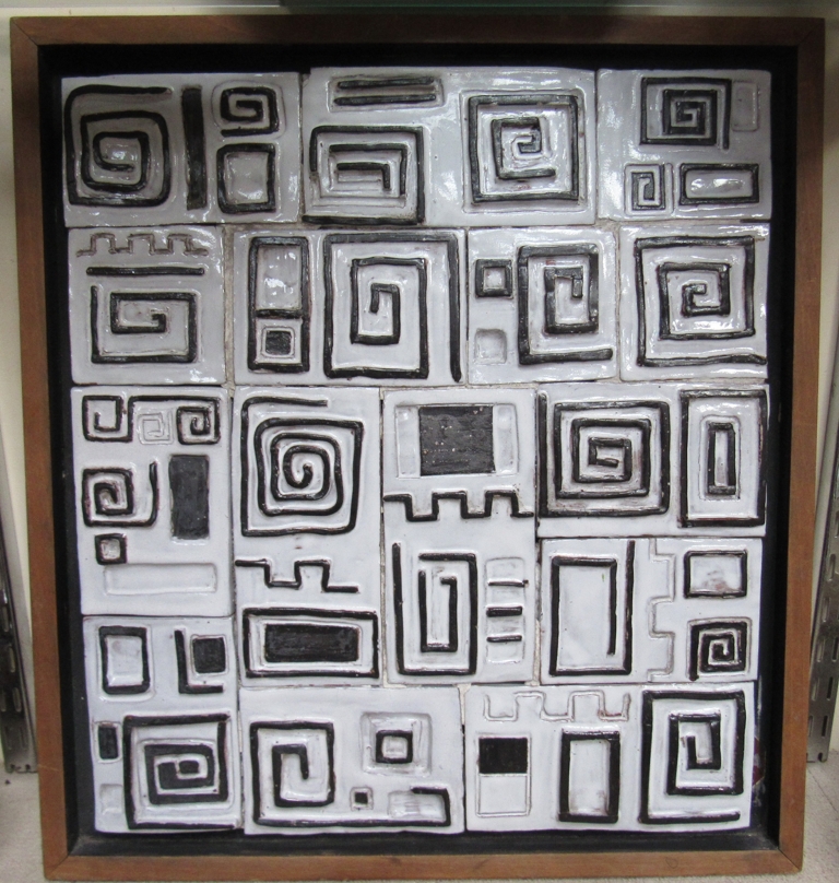 RON HITCHENS (XX):A framed ceramic tiled plaque, black and white glazed ...