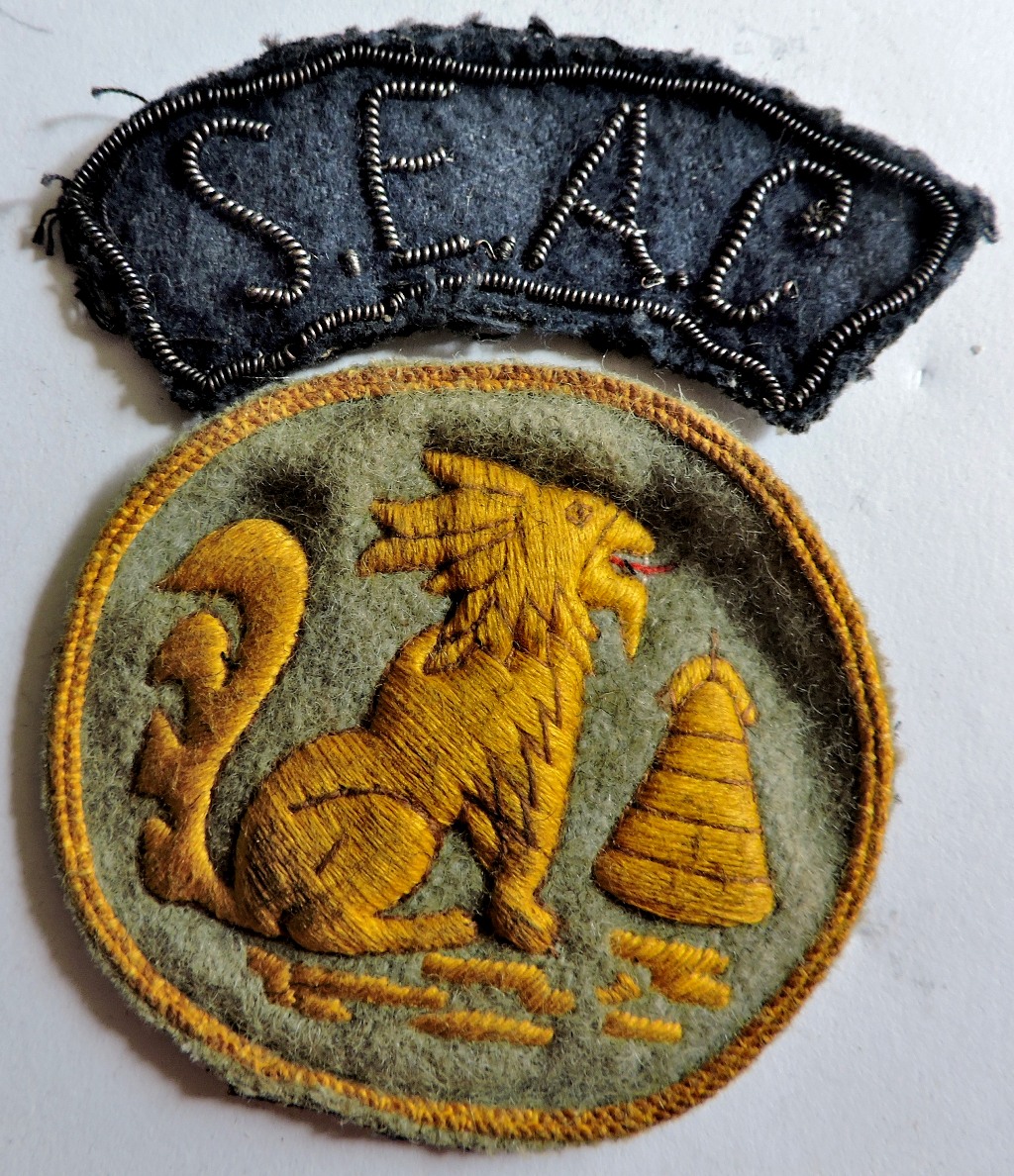 Chindits- a well worn chindit badge and an S.E.A.C shoulder title.